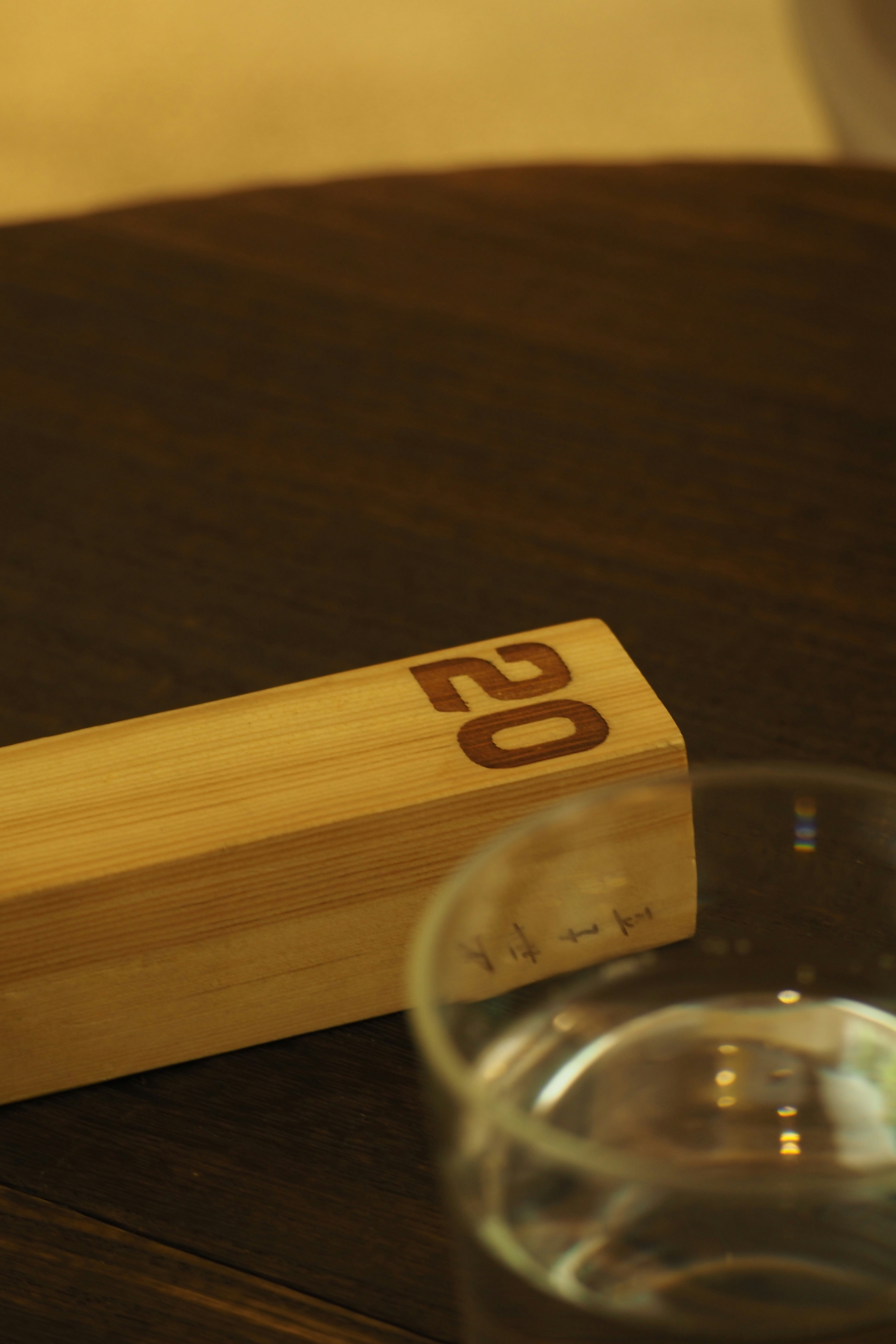 Stilled Ink: A Wooden Mark and Glass of Clarity