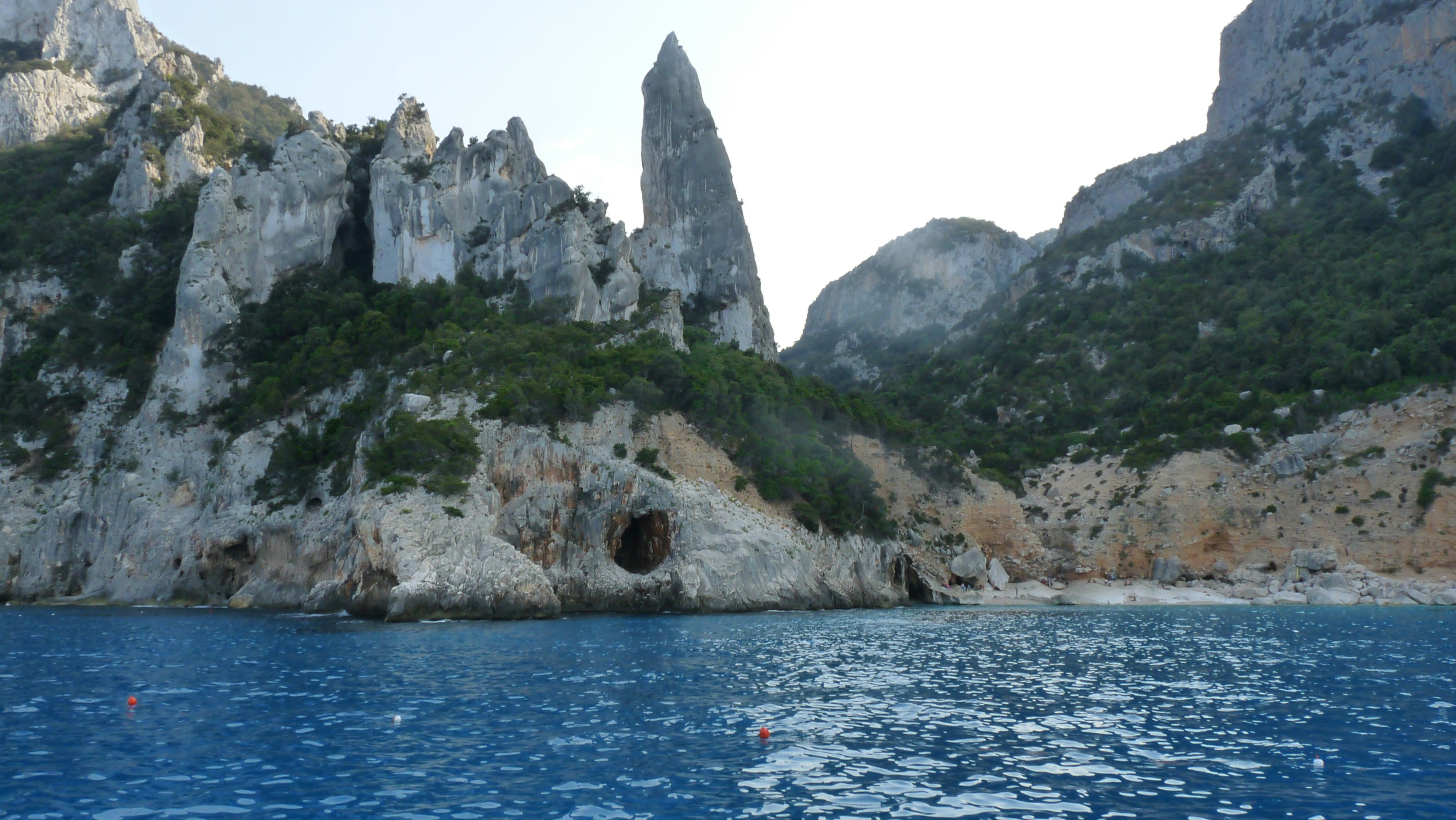 Sea Gate and Cliff Crown: A Cresting Skyline Above Quiet Blue Waters