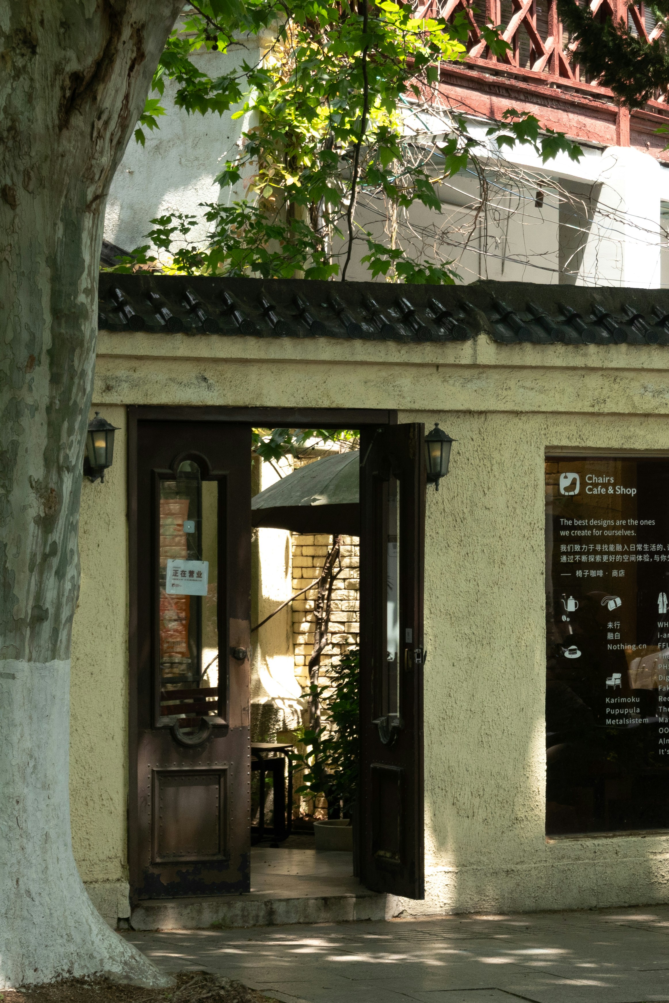 A cafe entrance with an open door and outdoor seating