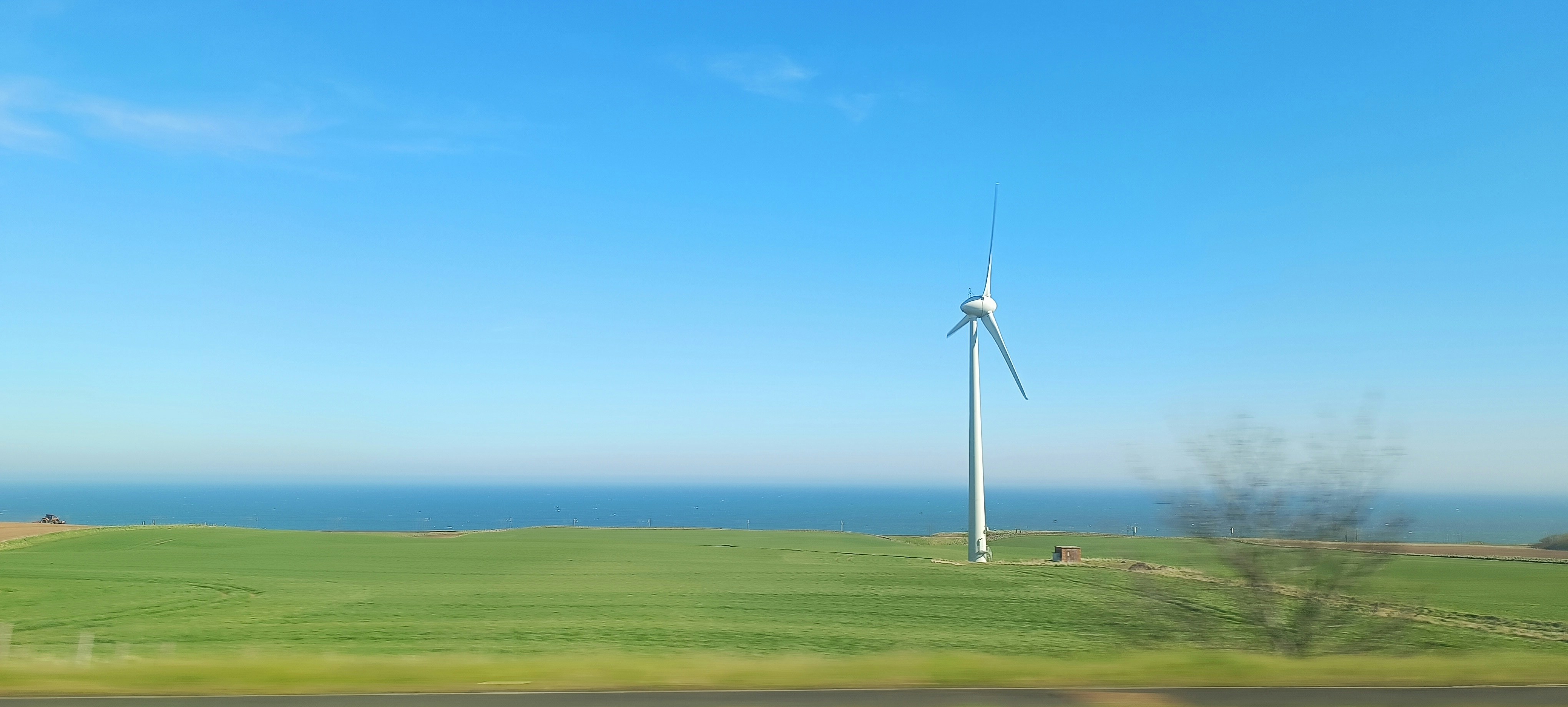 Coastal Greens and Aerial Rotor: Wind Turbine Quiet on the Horizon