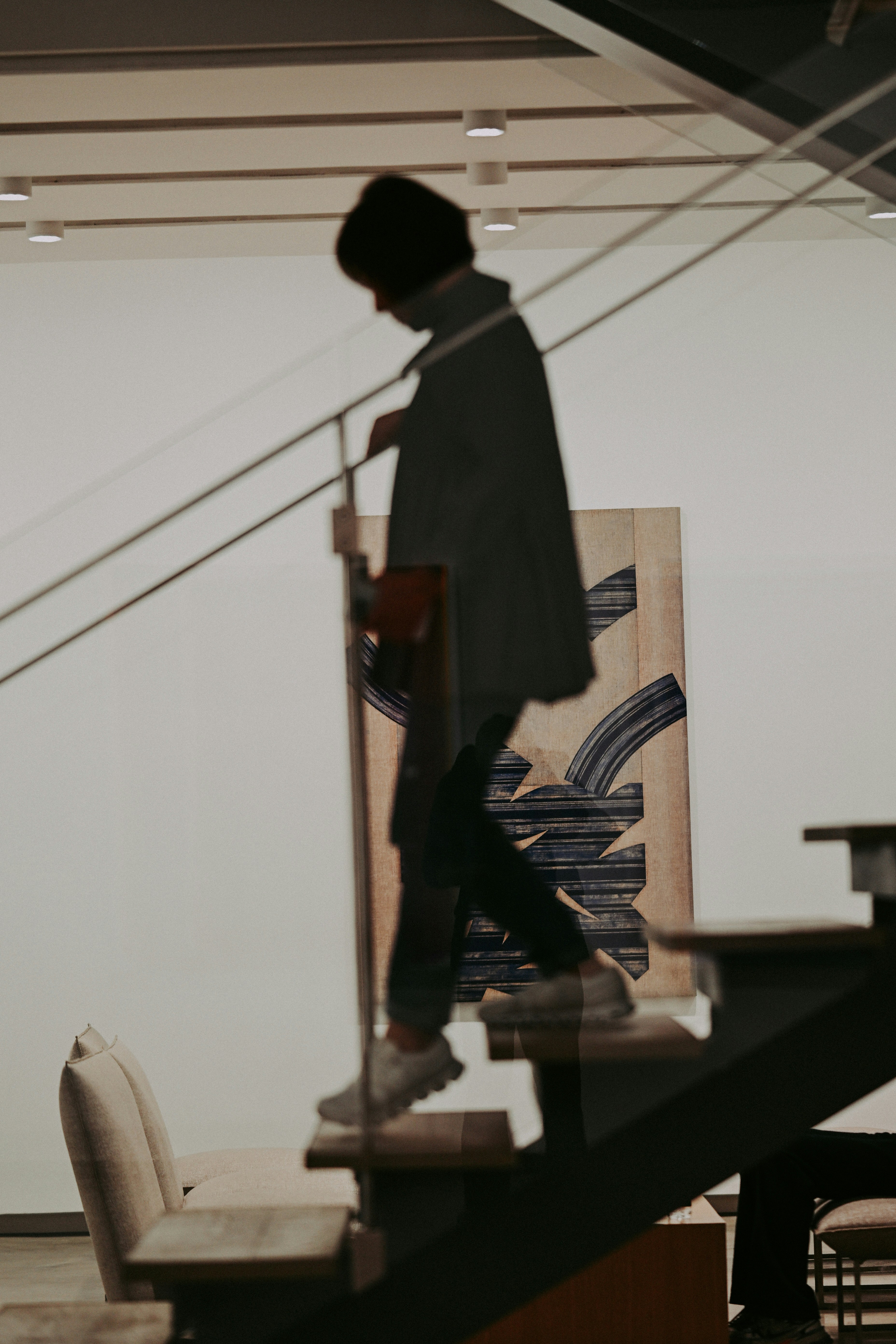 Muted movement along the gallery stairs