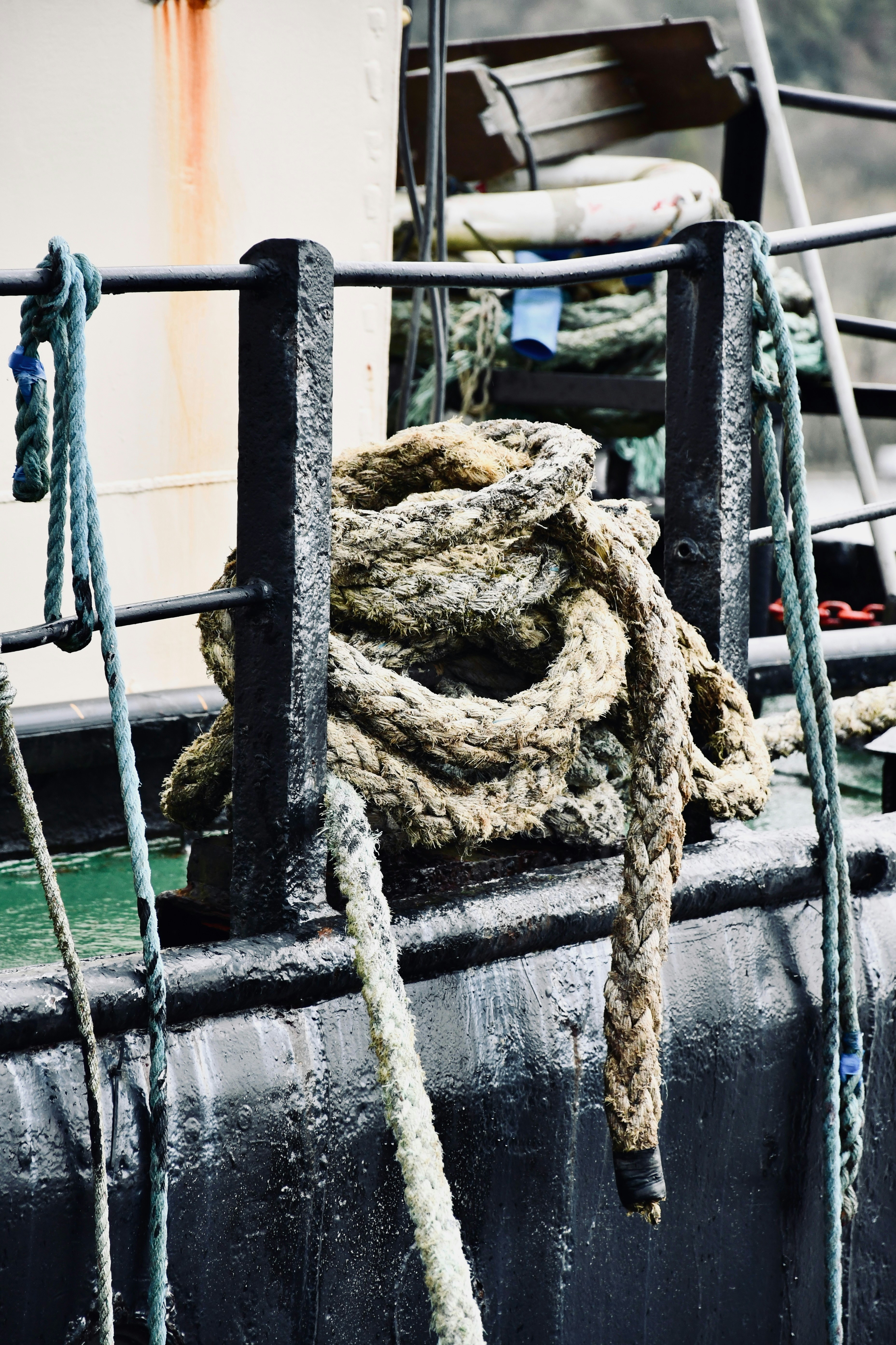 Tangled Mooring: A Coil of Ropes on a Weathered Vessel