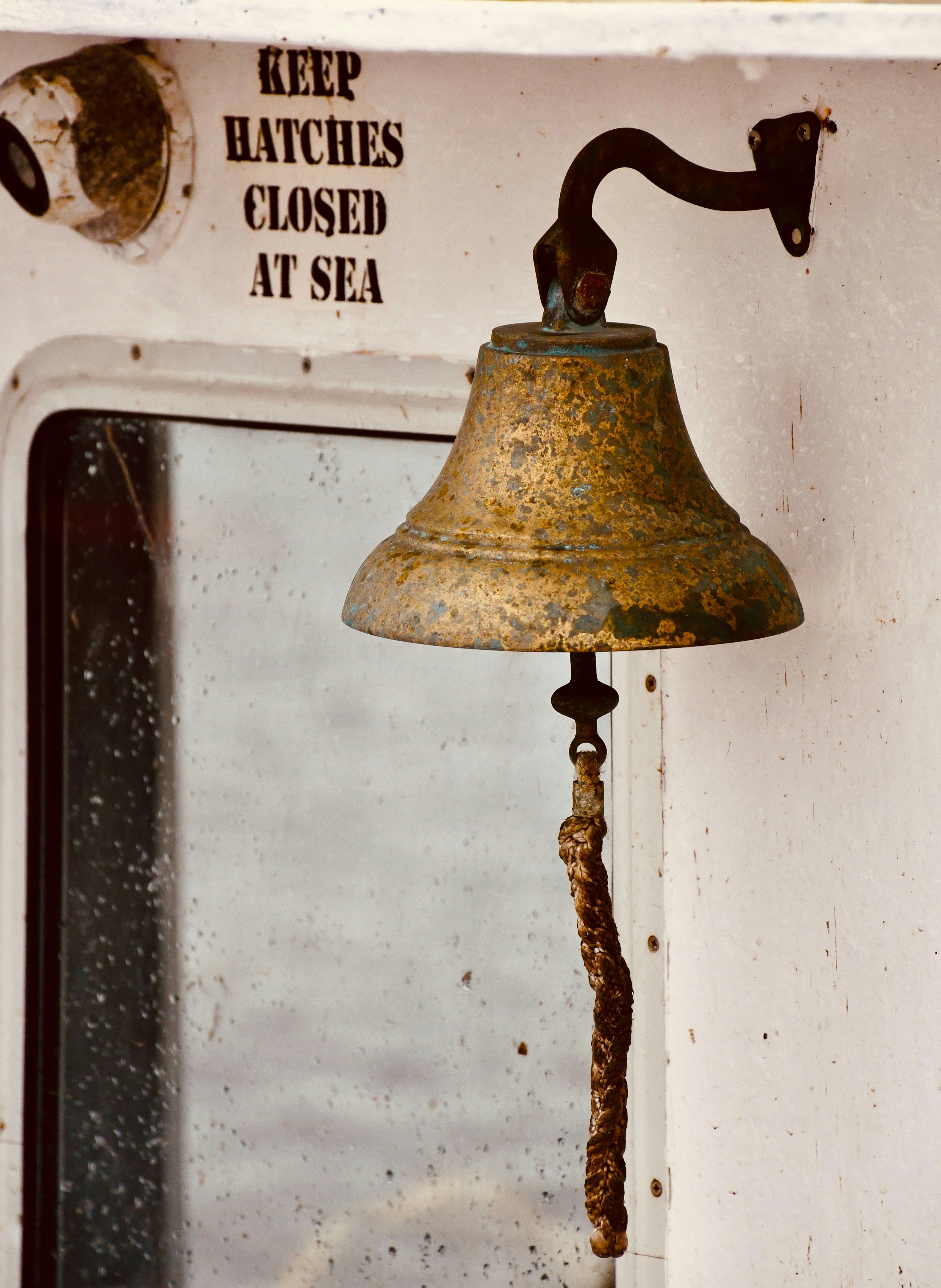 Rusty Sailor’s Bell Adrift on a Sea-Lalted Door