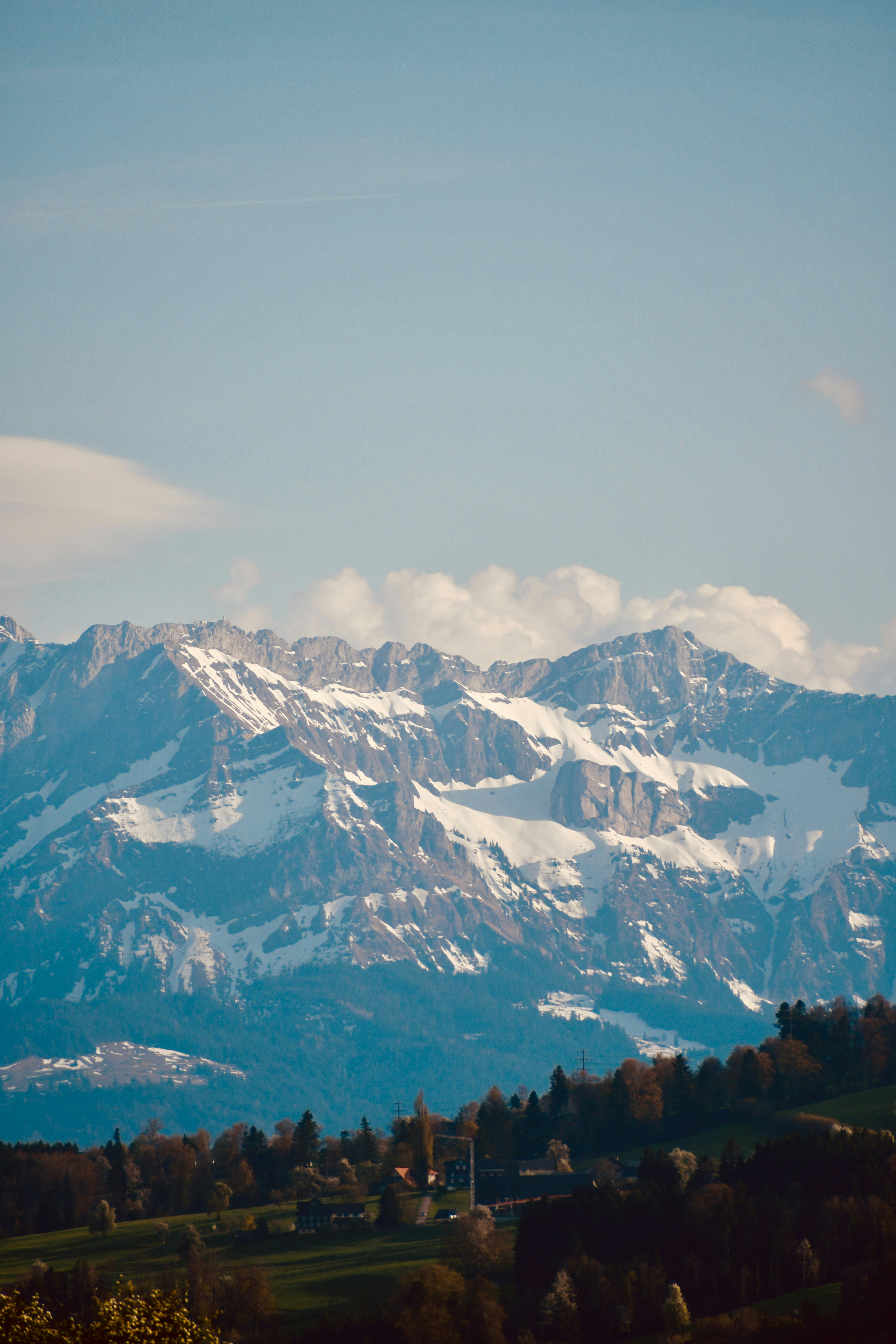 Snow‑dusted Peaks Over a Quiet Valley