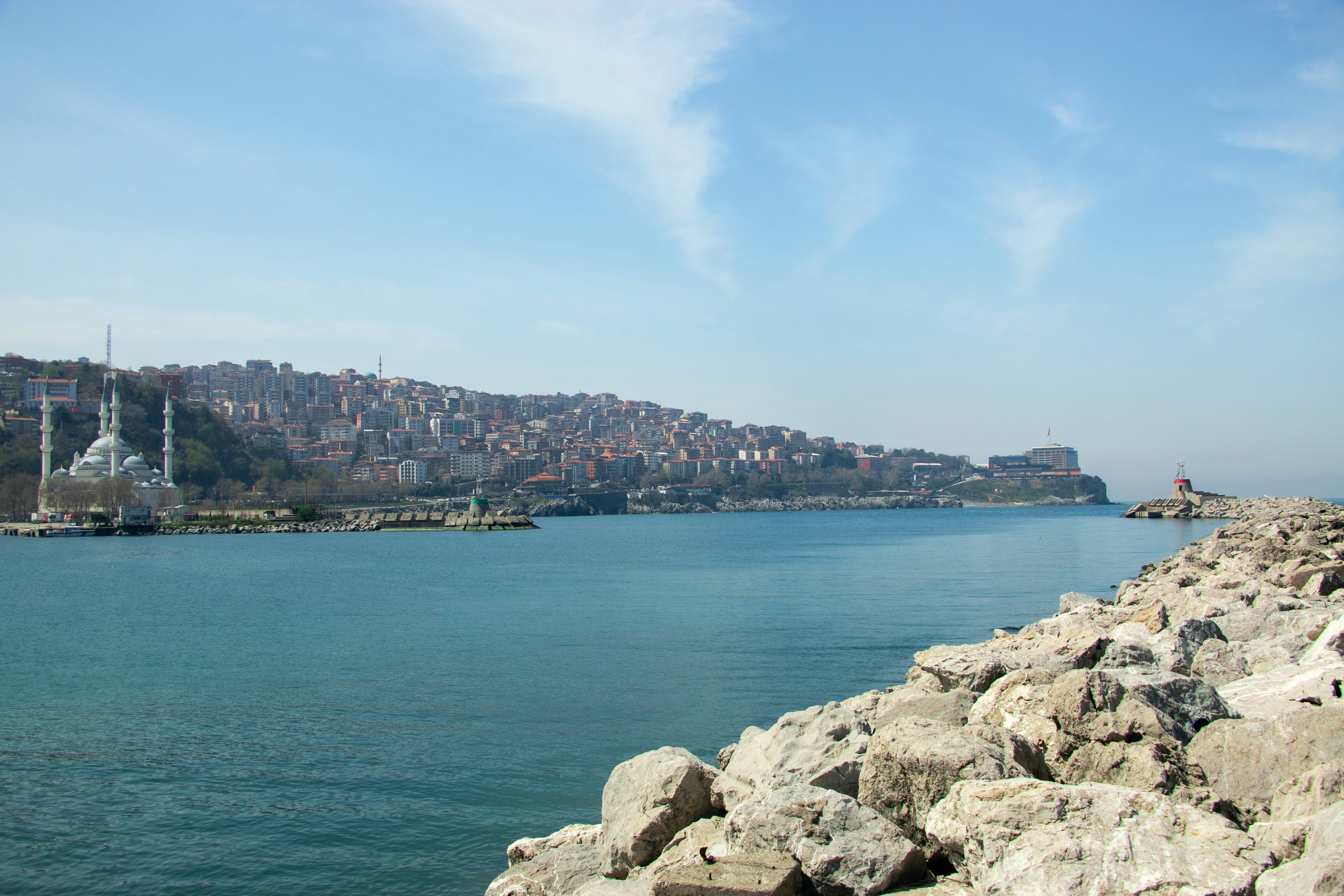 Harbor silhouettes: town rising along a calm turquoise inlet