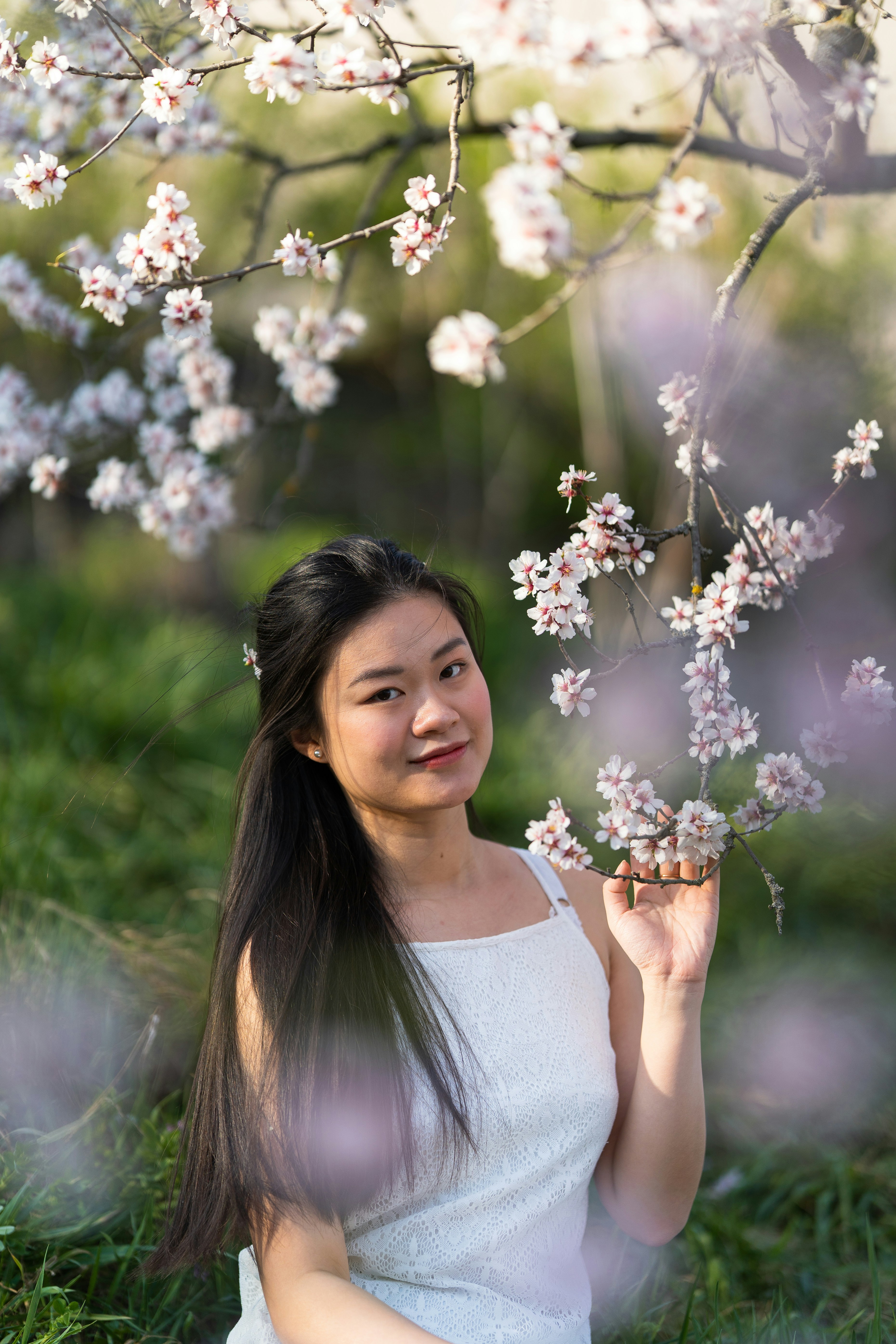 Blossoms and a Quiet Smile: Portrait Beneath Spring Buds