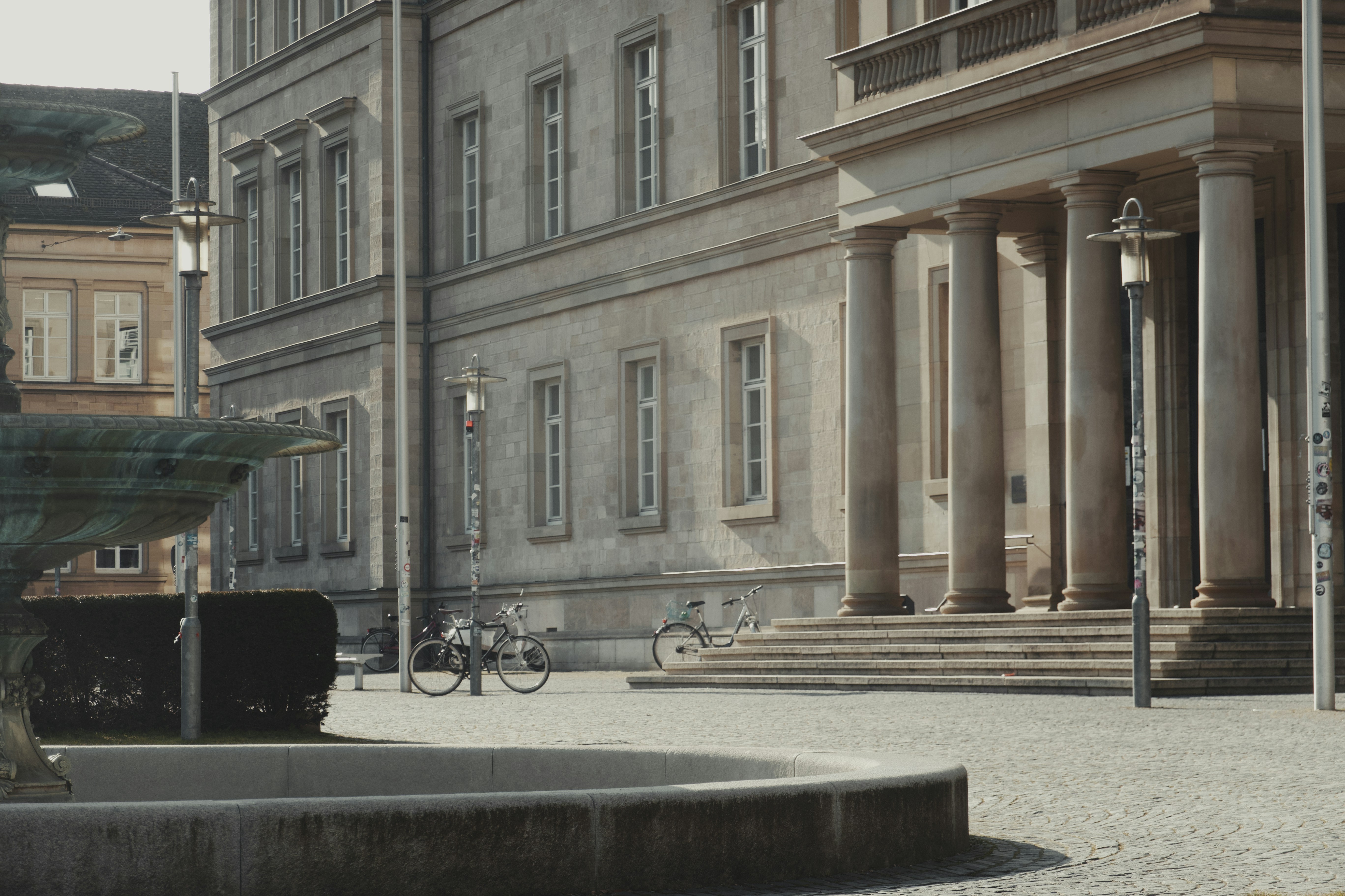 Stone Courtyard Portrait: Columns, Steps, and Quiet Facade
