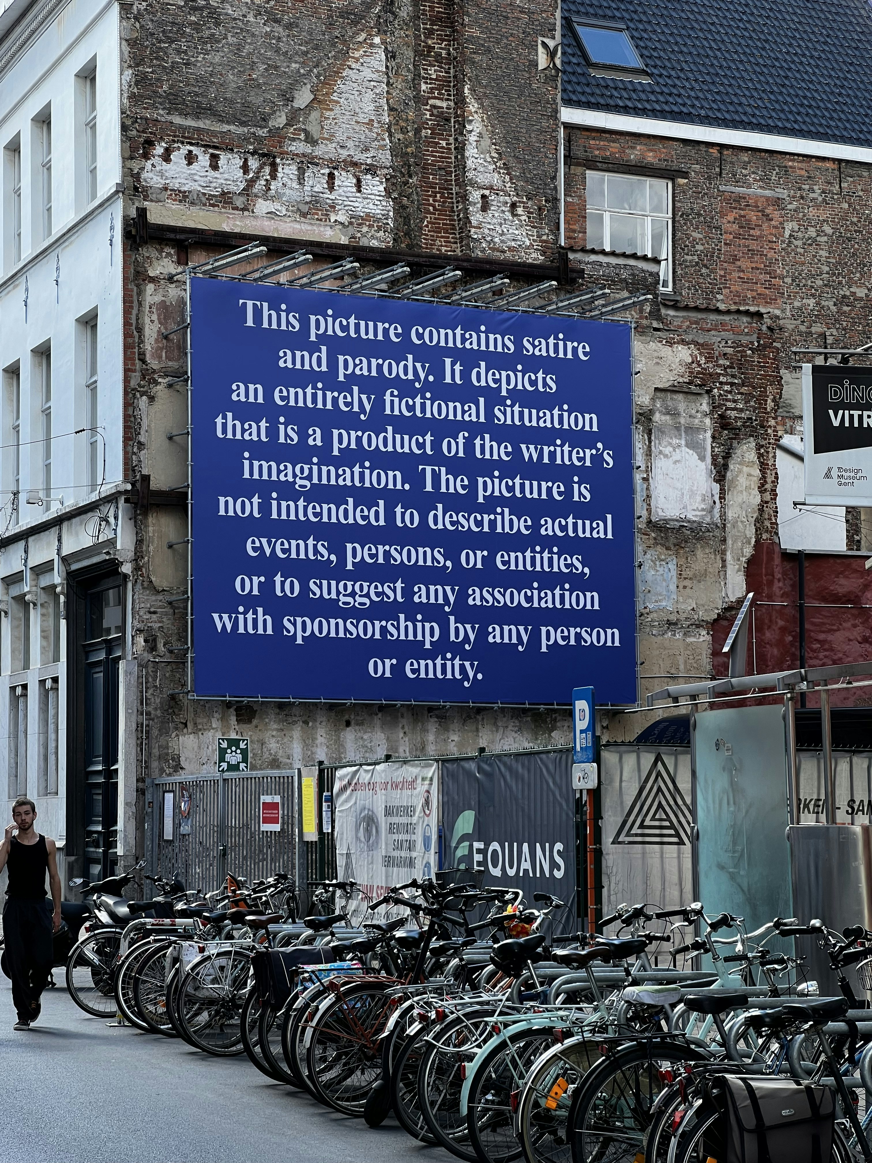 Blue Protest Banner Over a Busier Bicycle Street