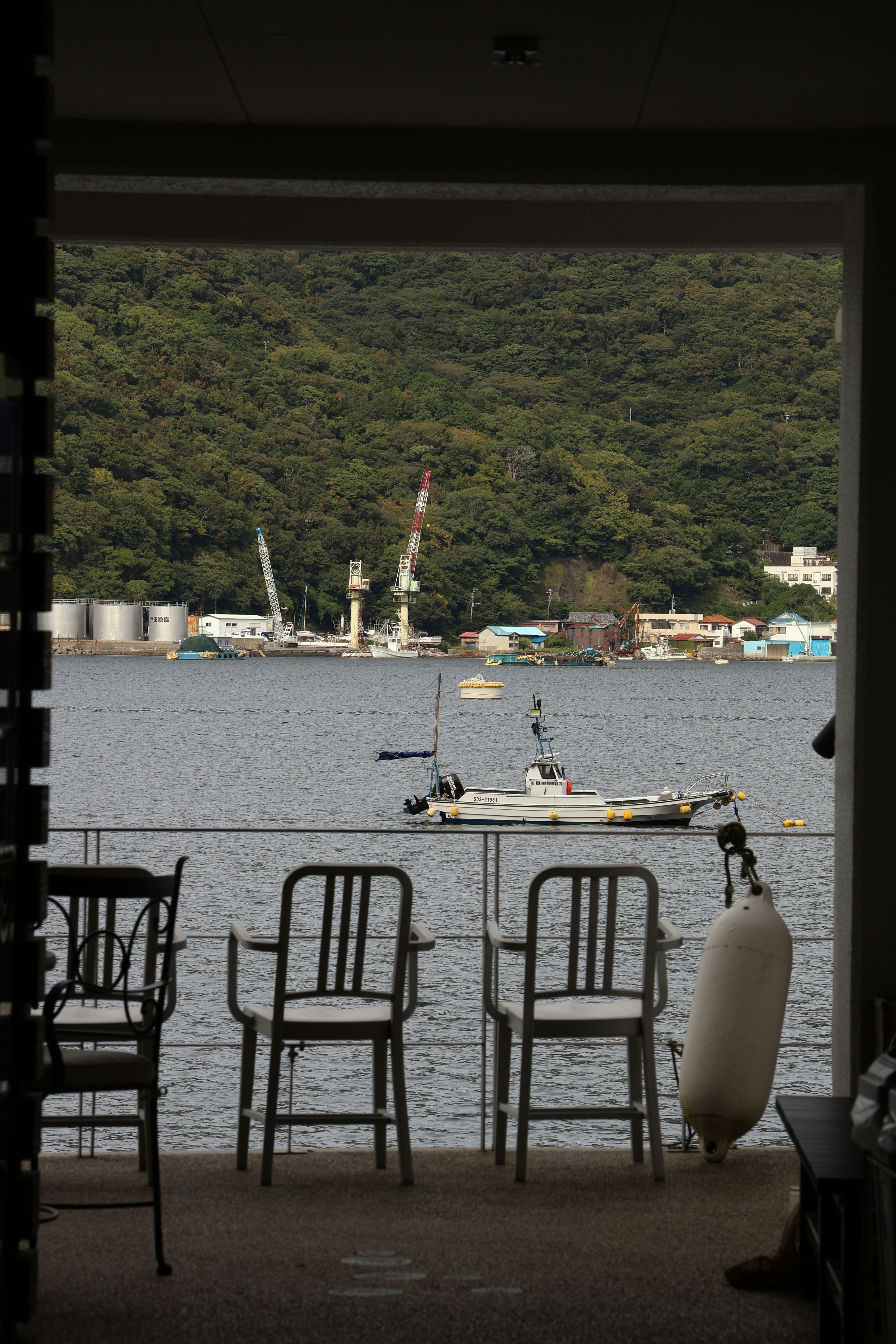 Harbor Frame: Boats and Cranes Beyond the Framed View