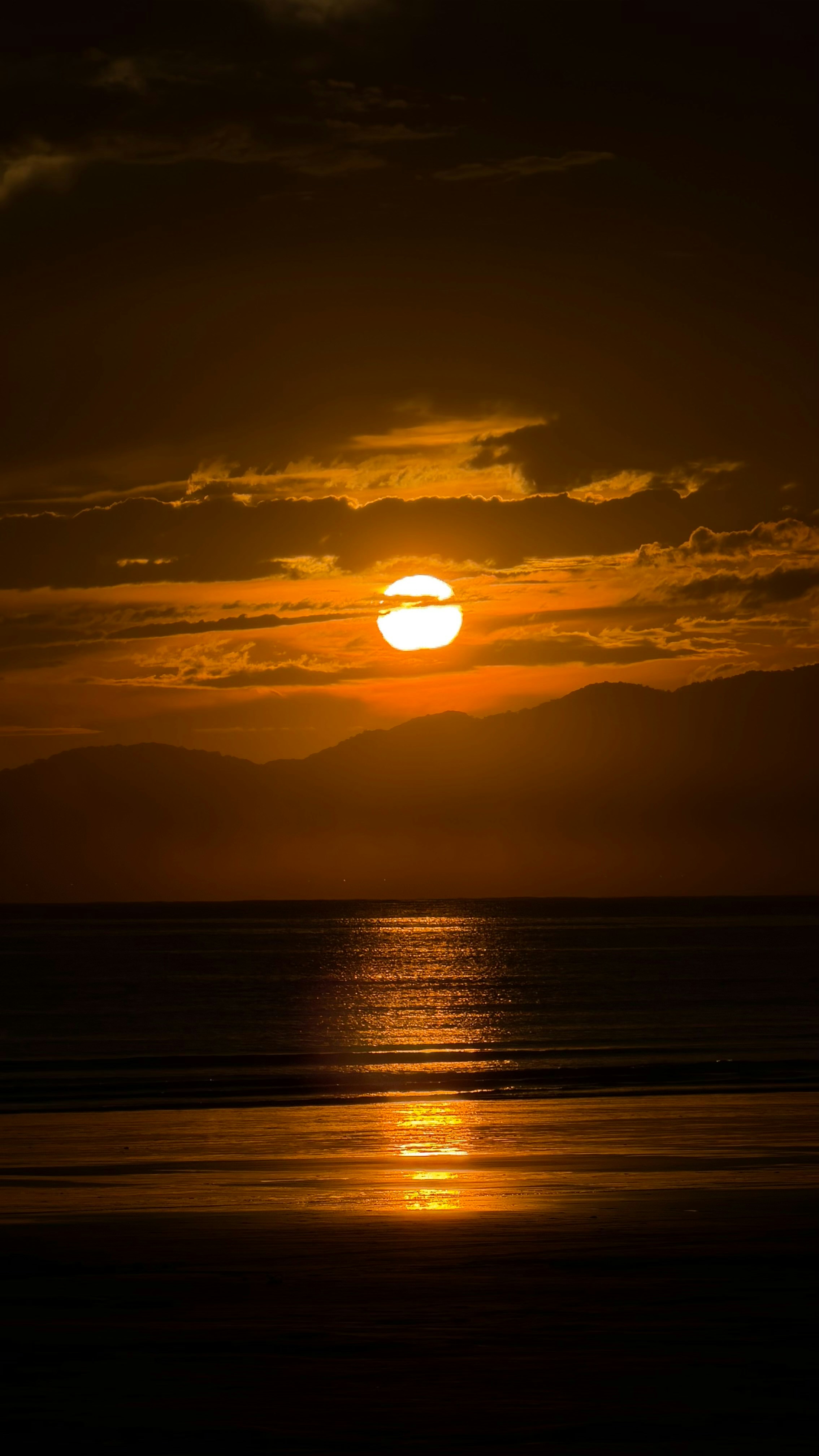 Fiery Meridian: The Sun Splits Over a Quiet Shore