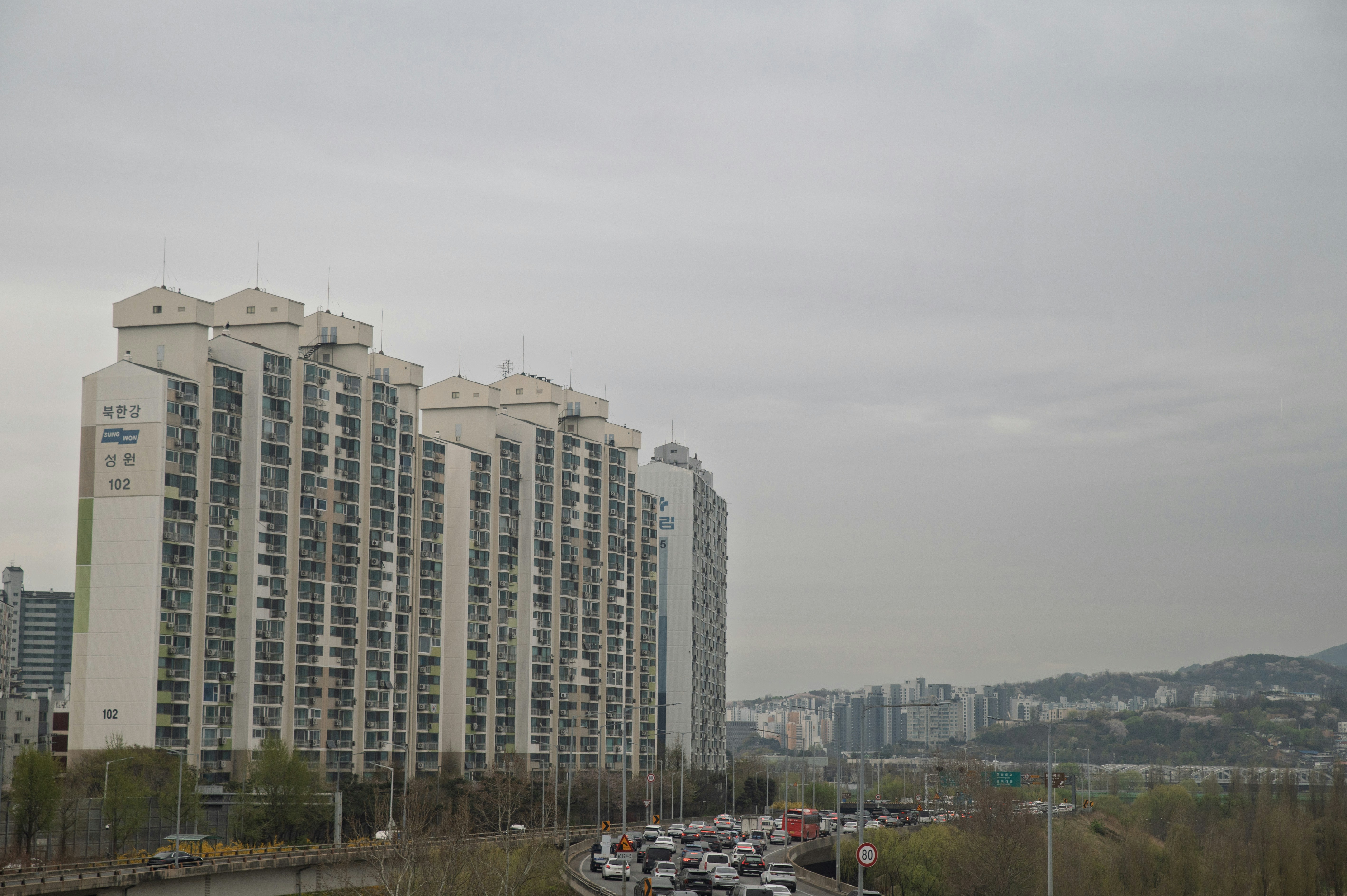 High-Rise Crest Over a Quiet Highway