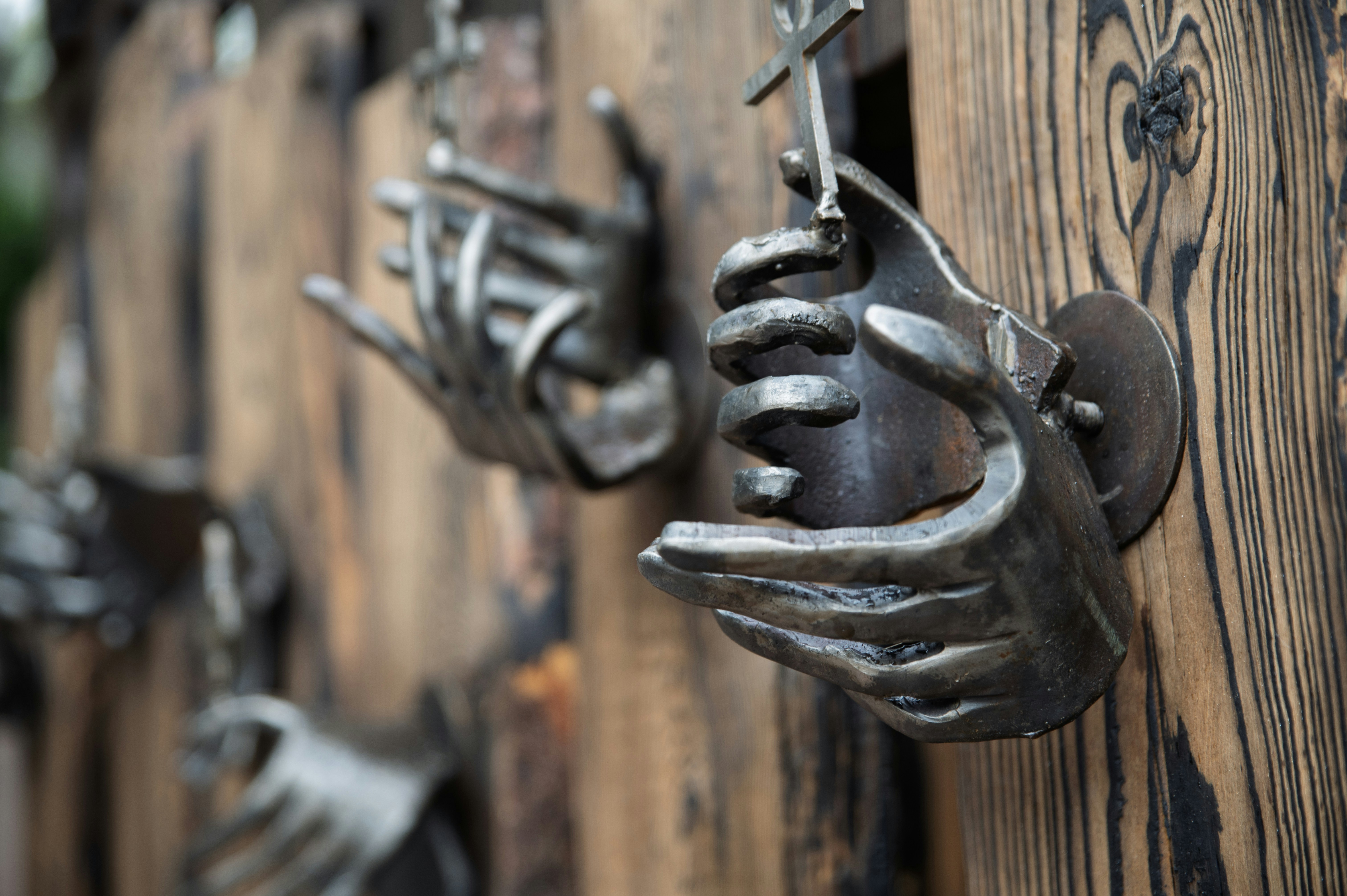 Hands of Time: A Row of Metal Crucifixes on Weathered Wood