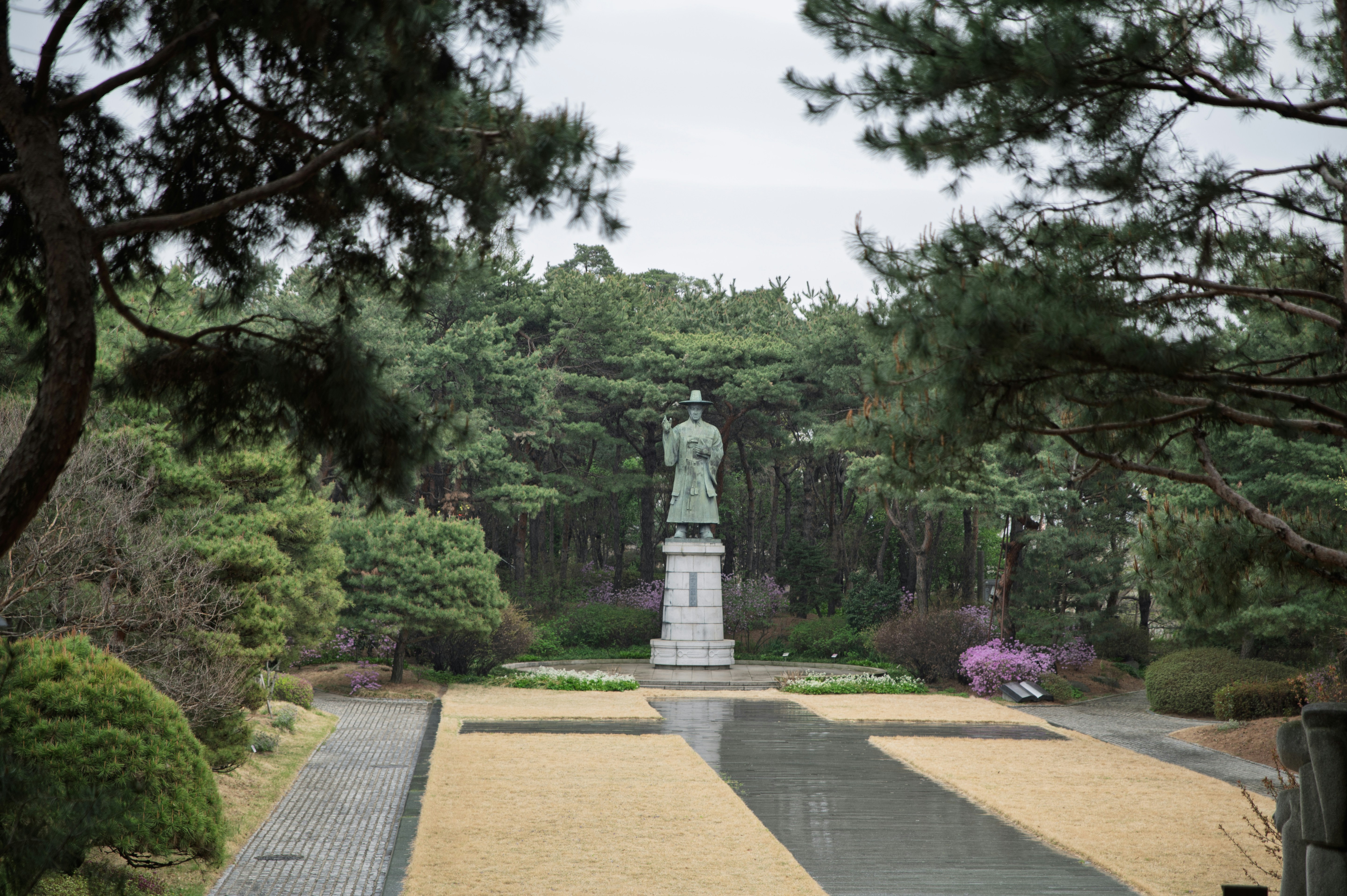  statuesque gaze: a solitary monument amid ordered gardens