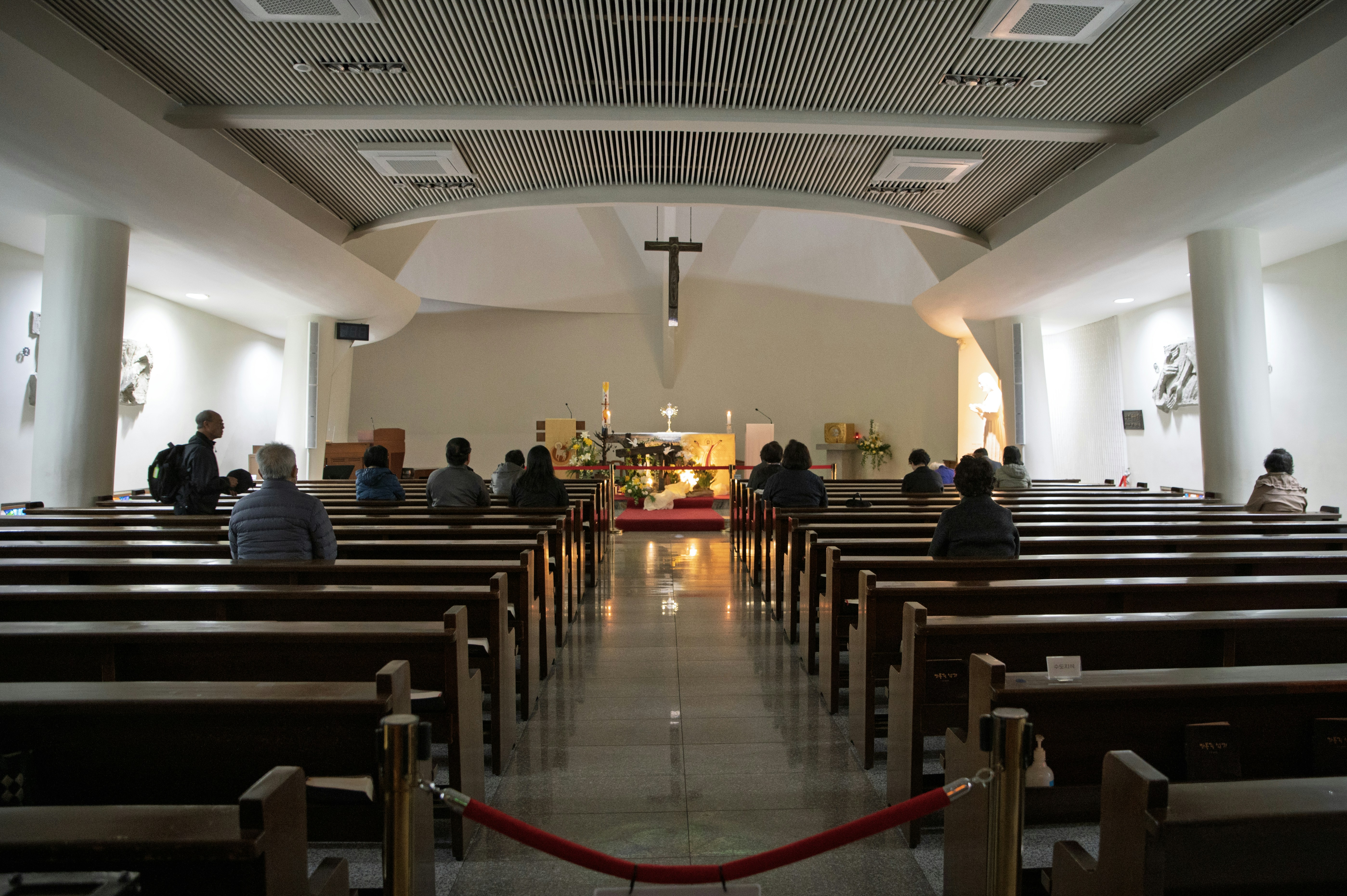 Quiet Congregation Seated in a Sunlit Church Hall