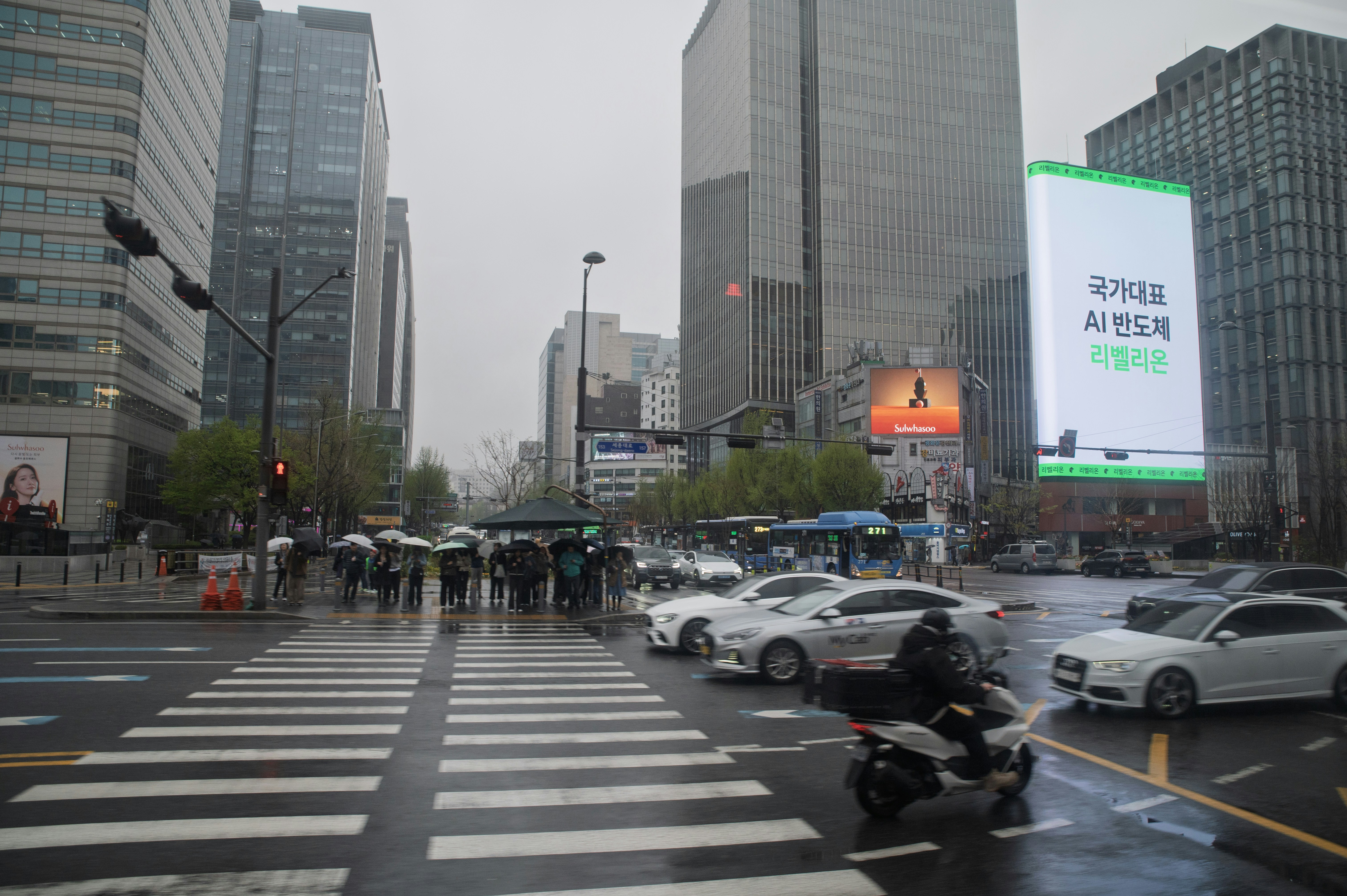 Crosswalk Confluence: Rainy City Pulse Beneath Neon Towers