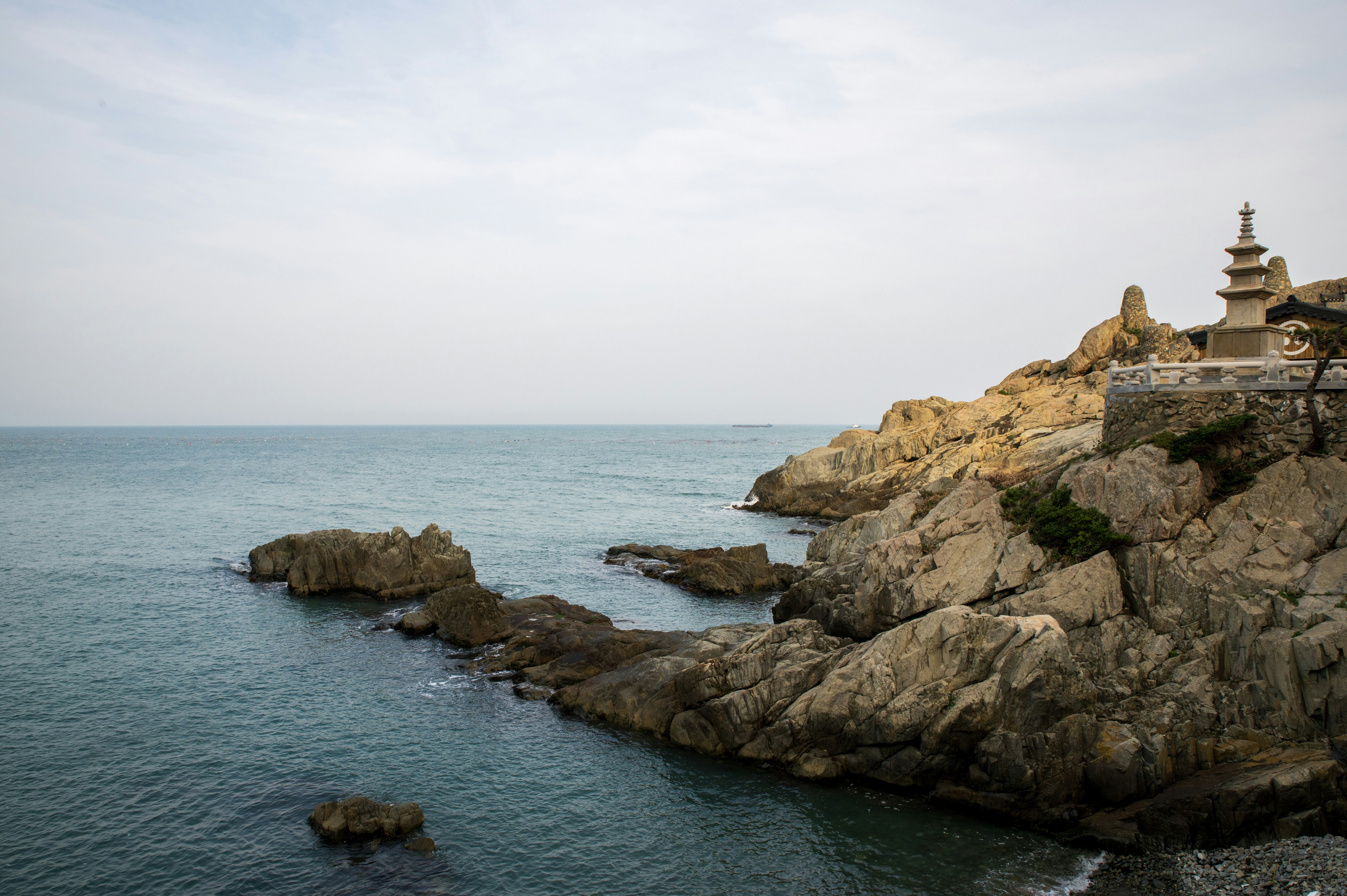 Rocky Promontory with a Lantern-Topped Structure Solidified Against the Sea