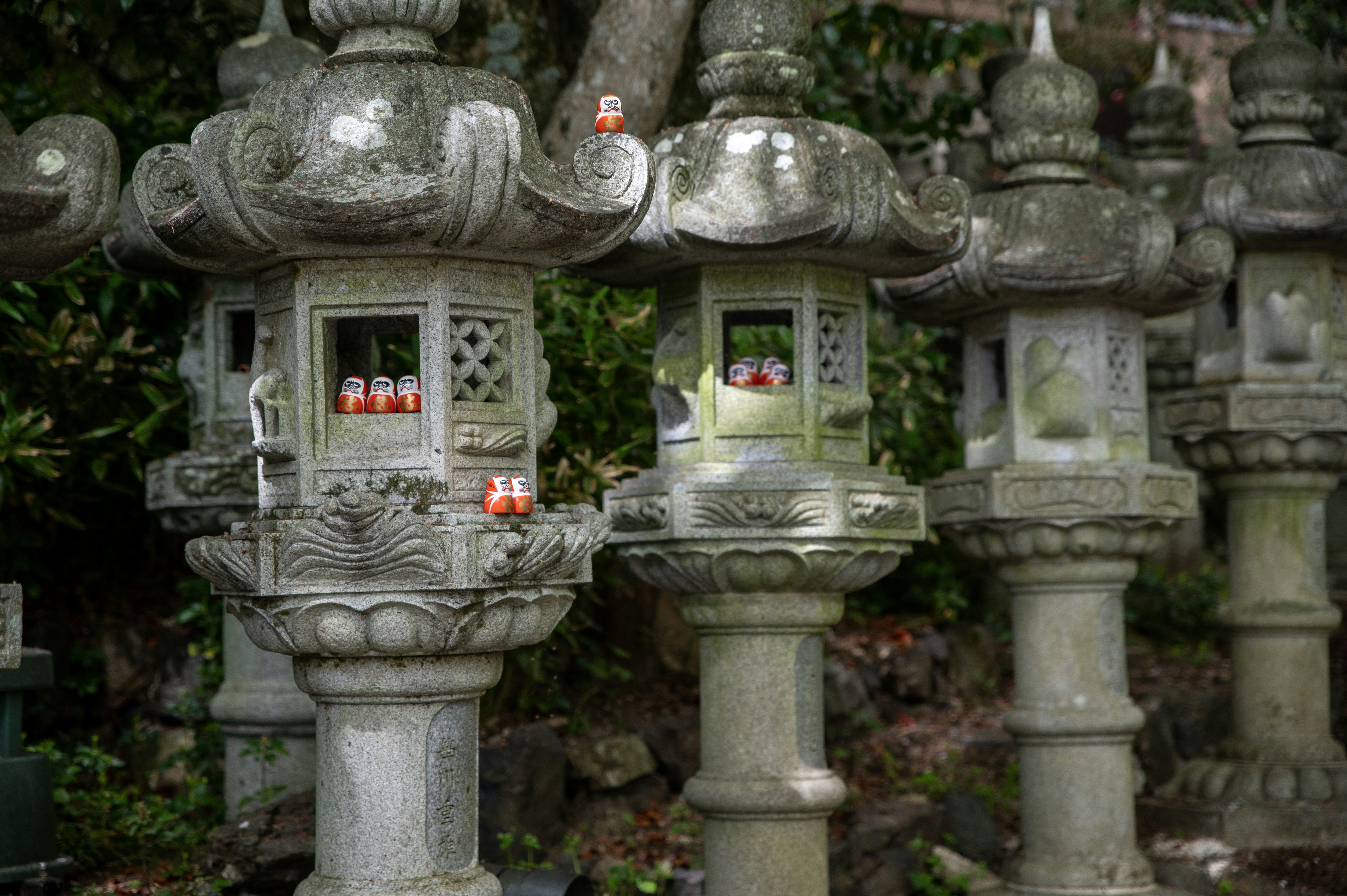 Row of Weathered Lanterns with Red Offerings