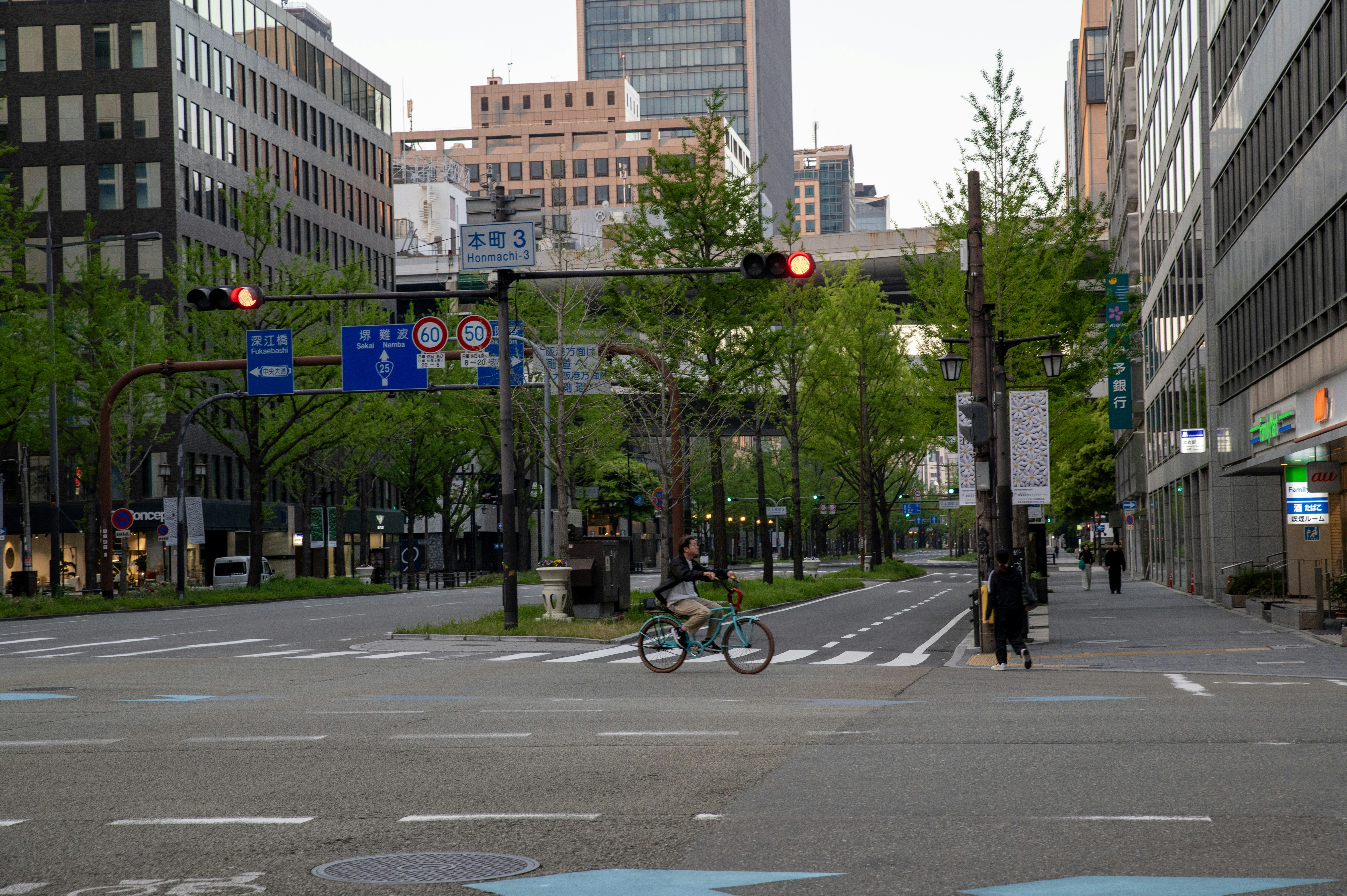 Urban Crossing: Cyclist Pause at a Quiet City Intersection