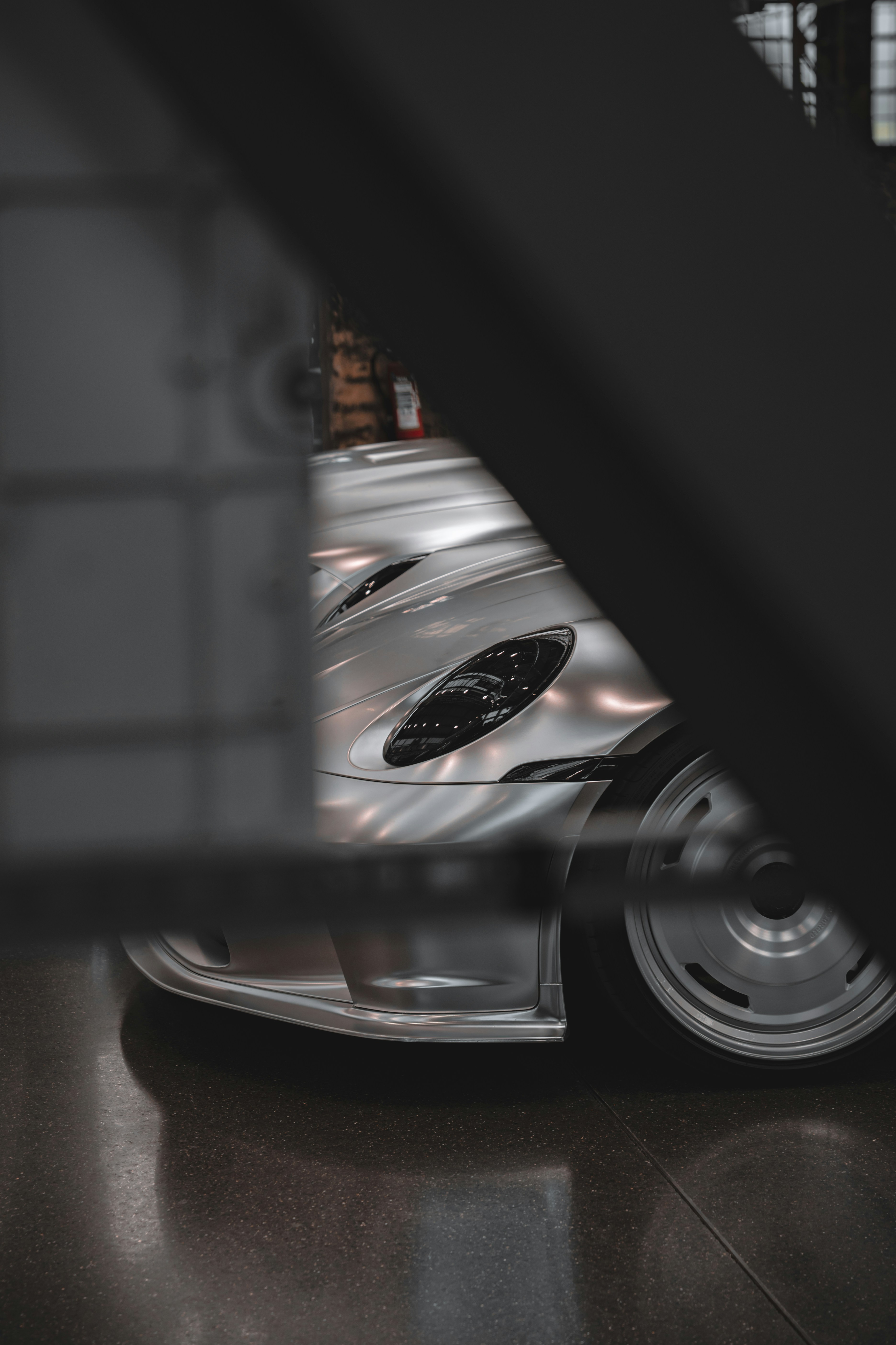 Silver Porsche Emerges Through a Geometric Gap