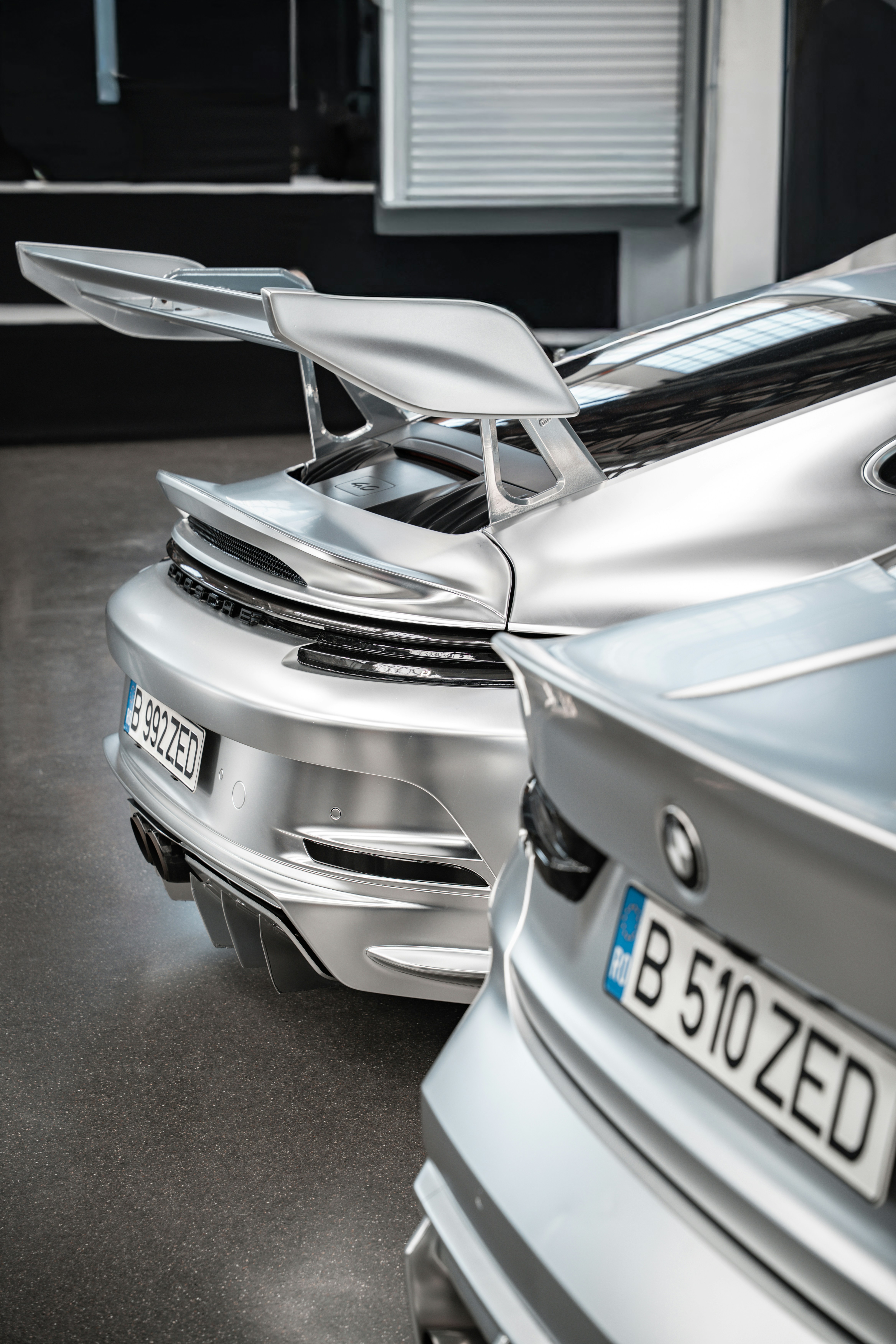 Twin Silver Spoilers: A Pair of Sleek Cars in a Modern Garage