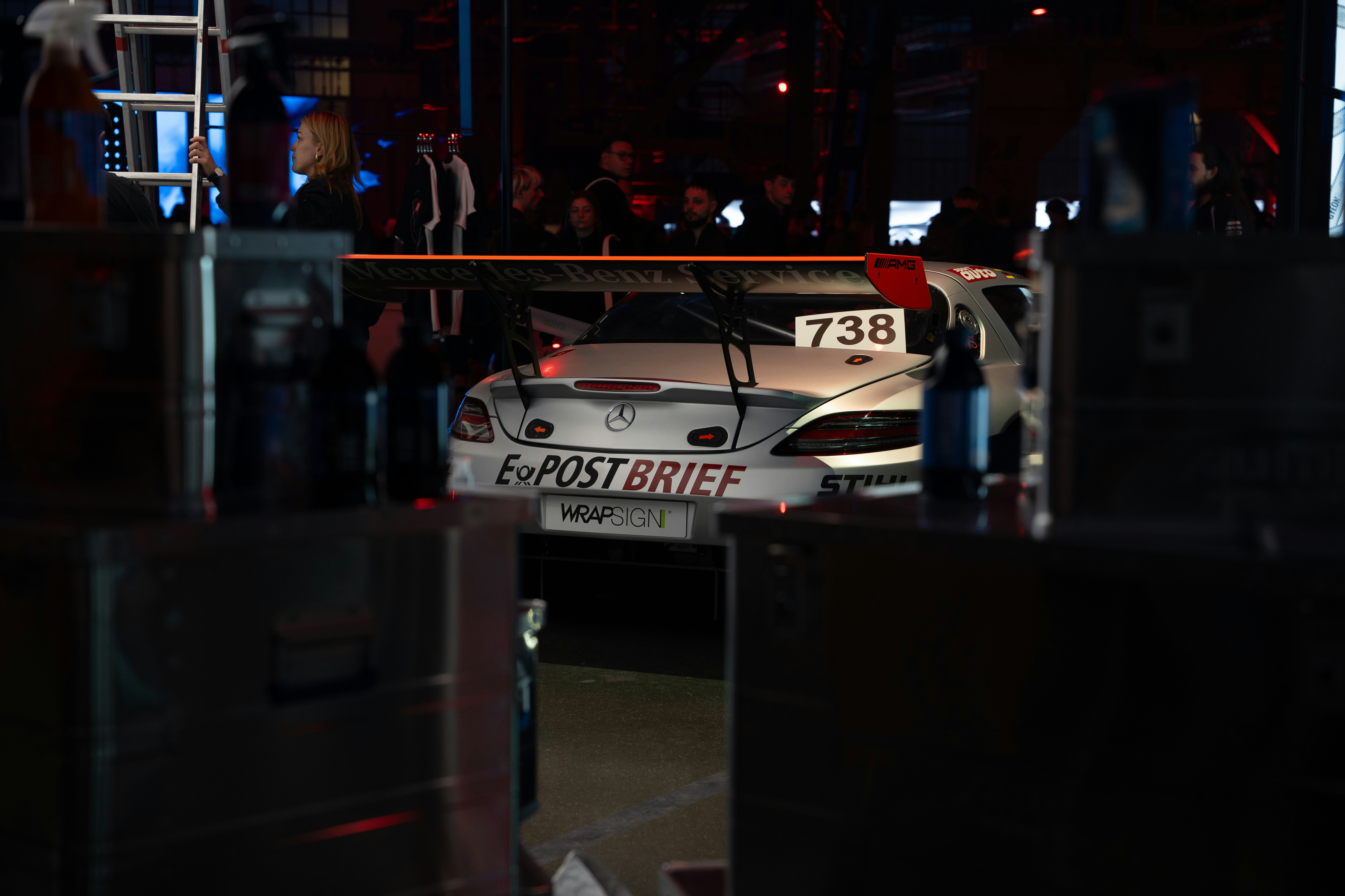 Racing Pit Under Neon Lights: A White Porsche 738