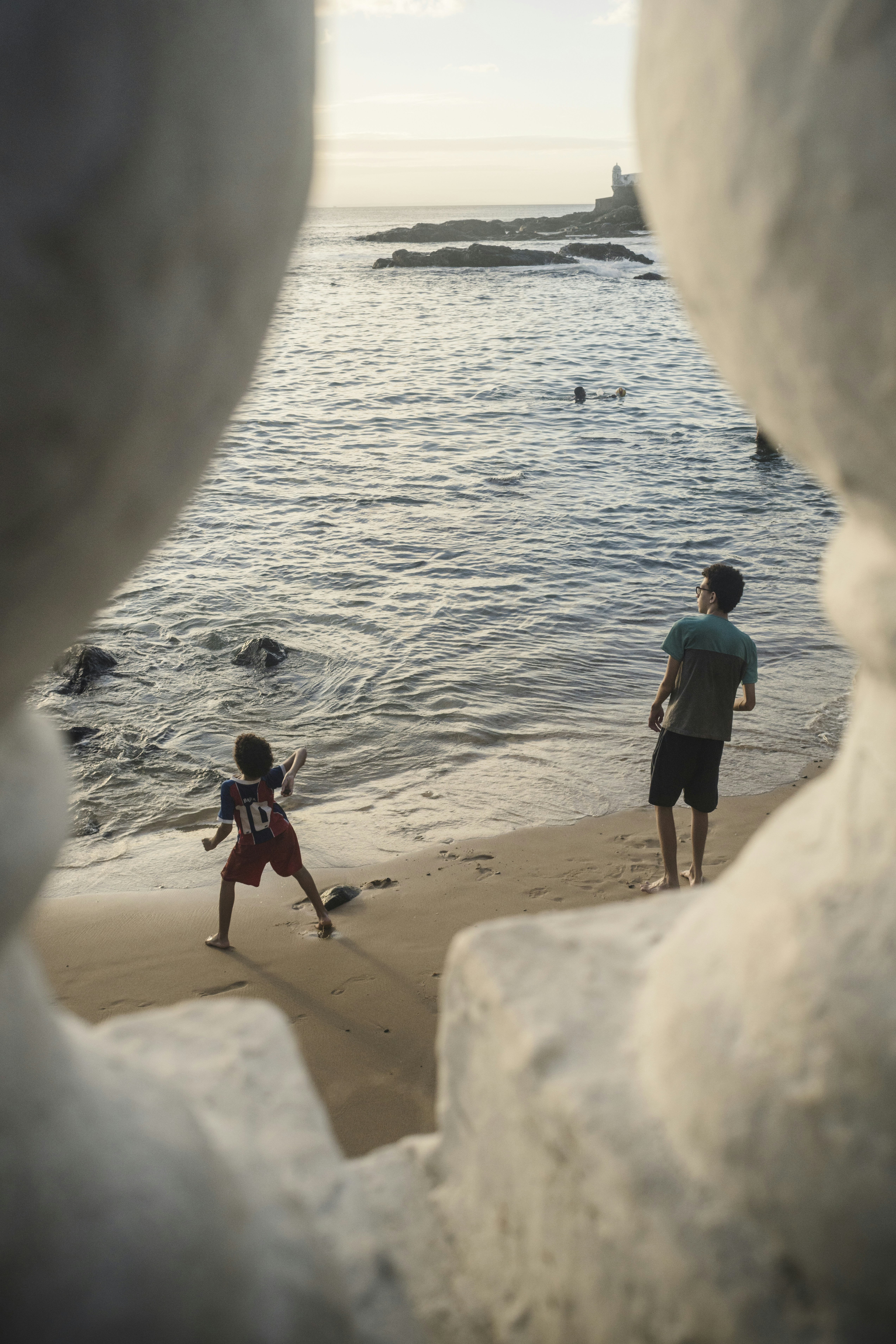 Framed by Stone Giants: Children at the Quiet Shore