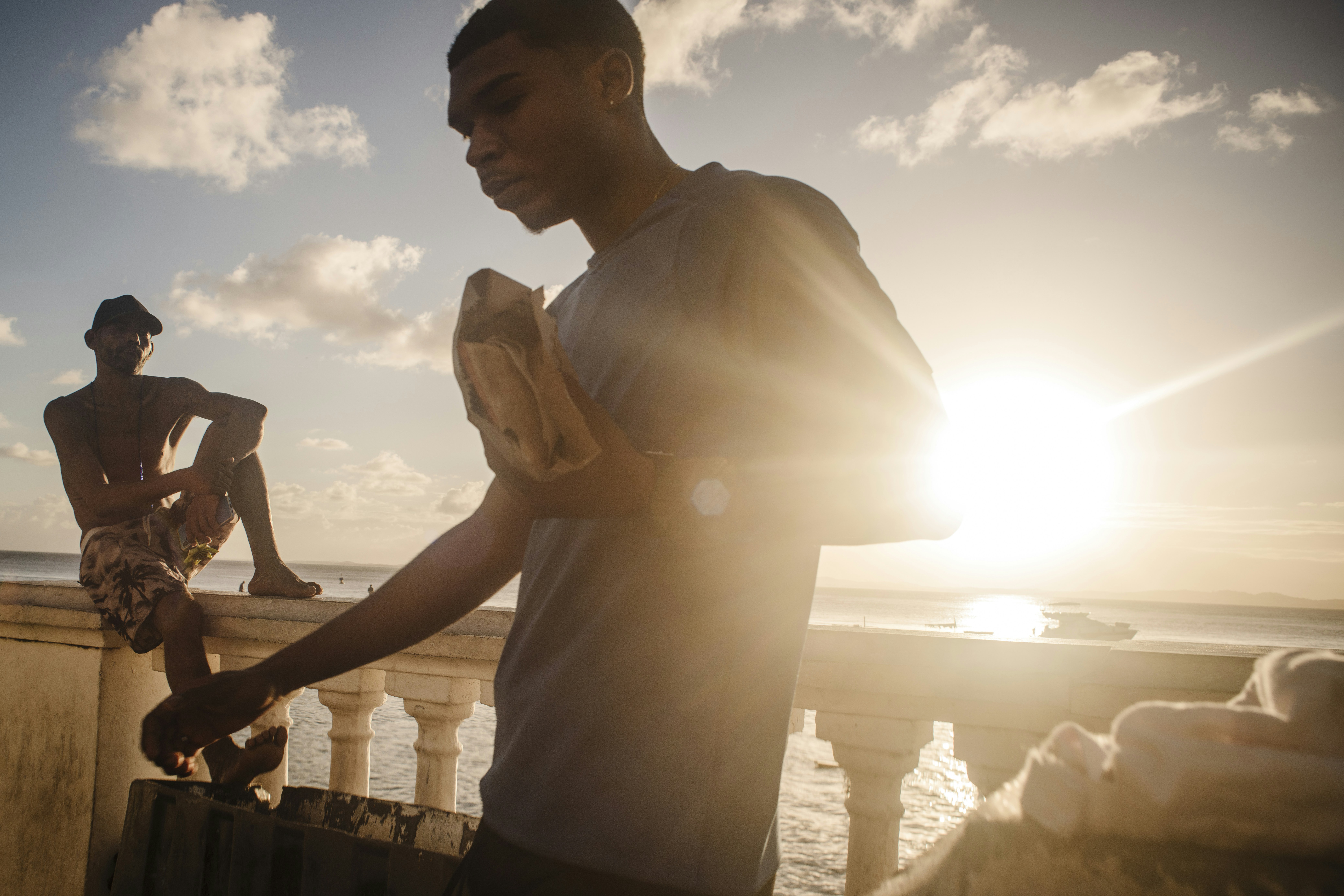 Sunlit Moment on the Pier: Youthful Ambition in the Shoreline Glow