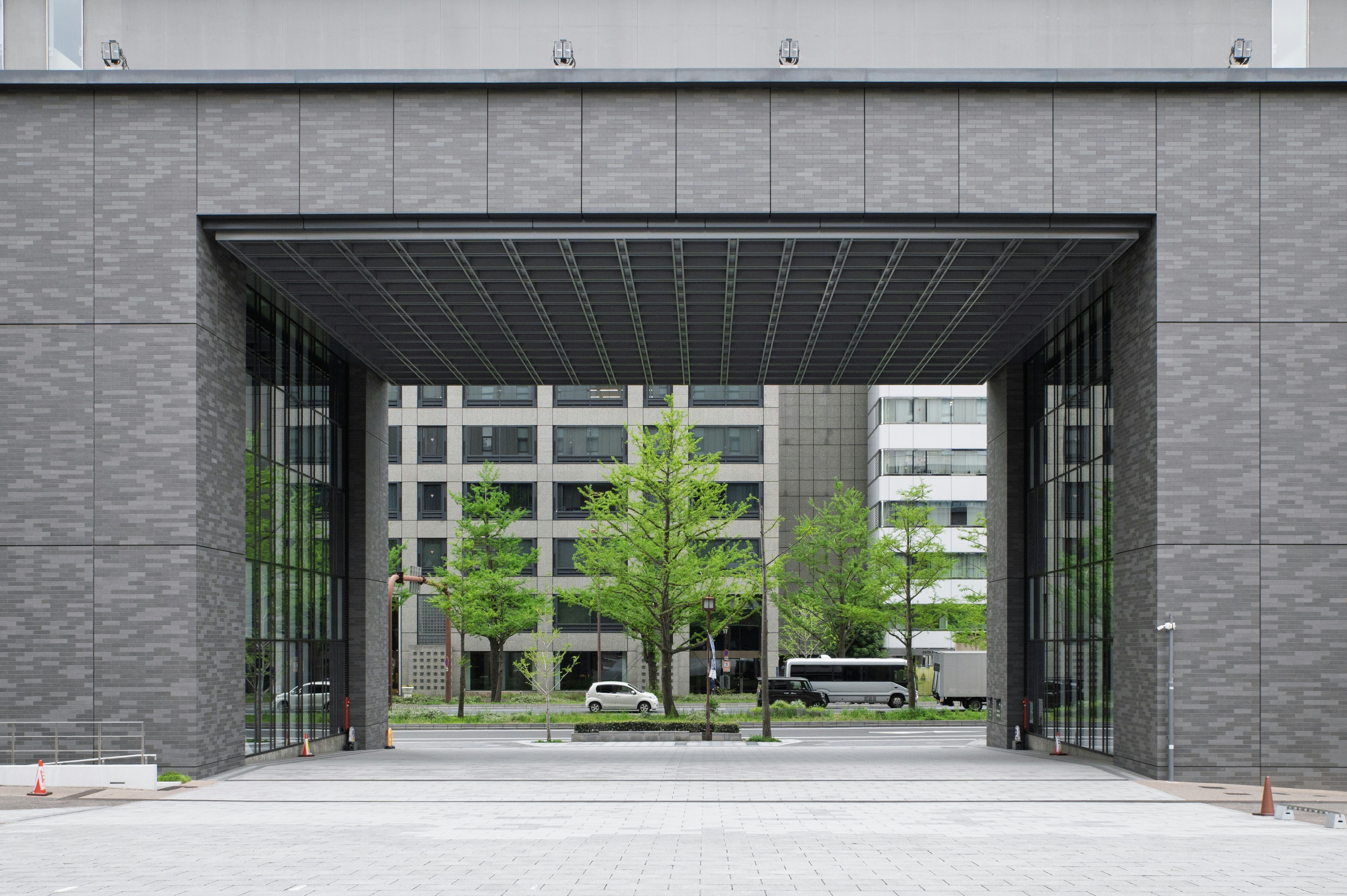 Gateway Framed: A Modern Courtyard Sits Beyond a Dark Stone Archway