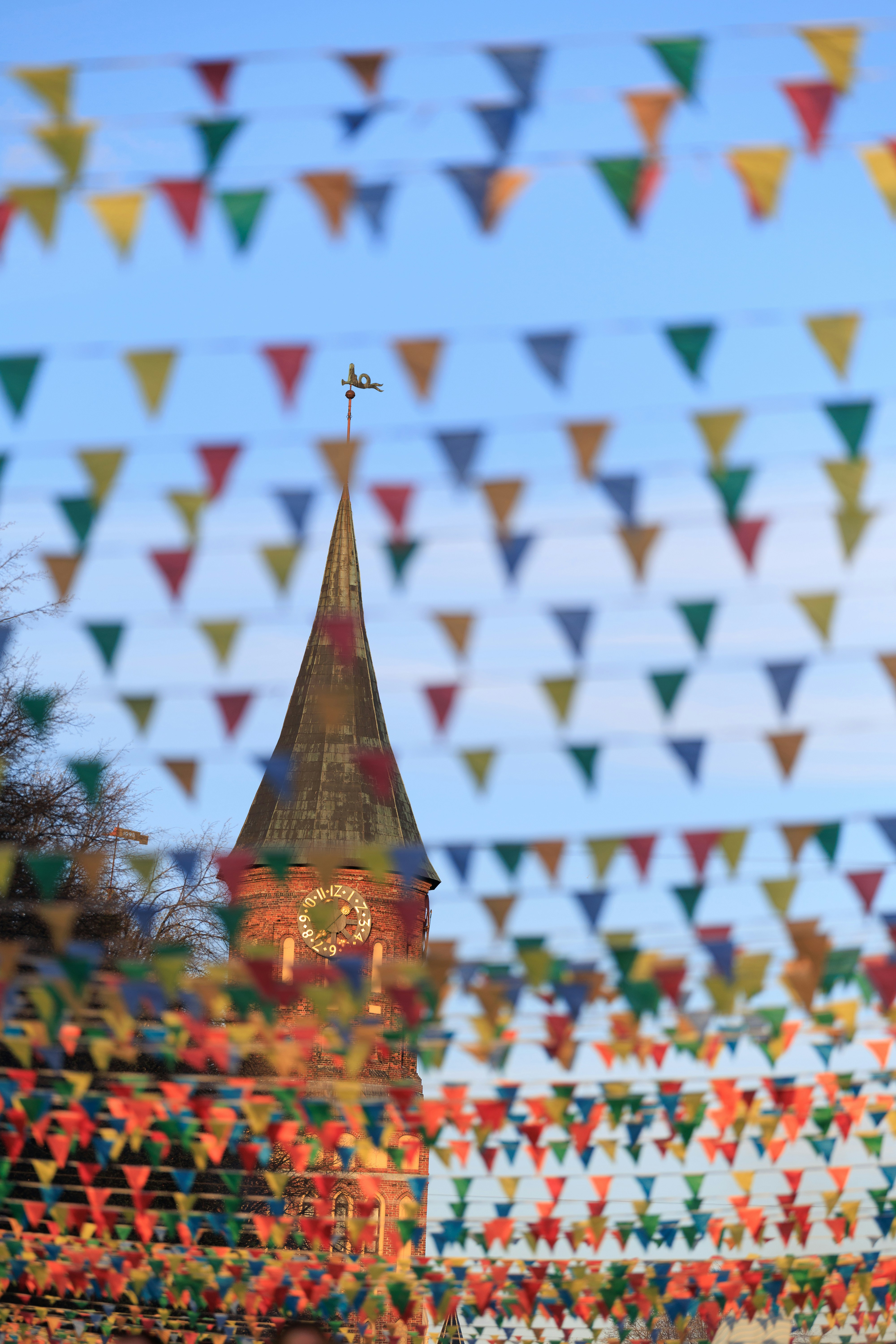 Flagged Sky and Clocktower: A Festive Facade Under Colorful Banners