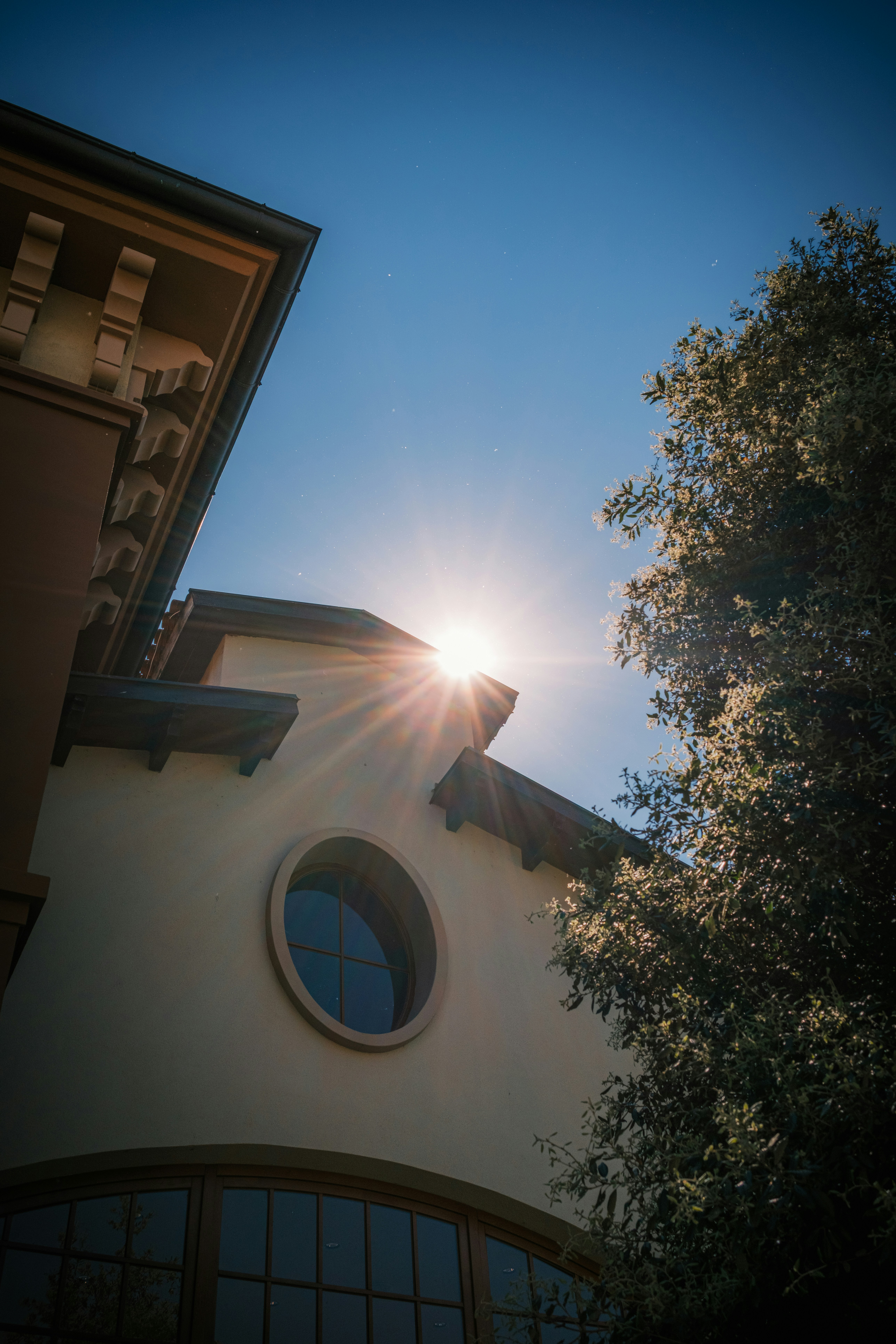 Sunlit Facade: Architectural Silhouette with a Radiant Burst