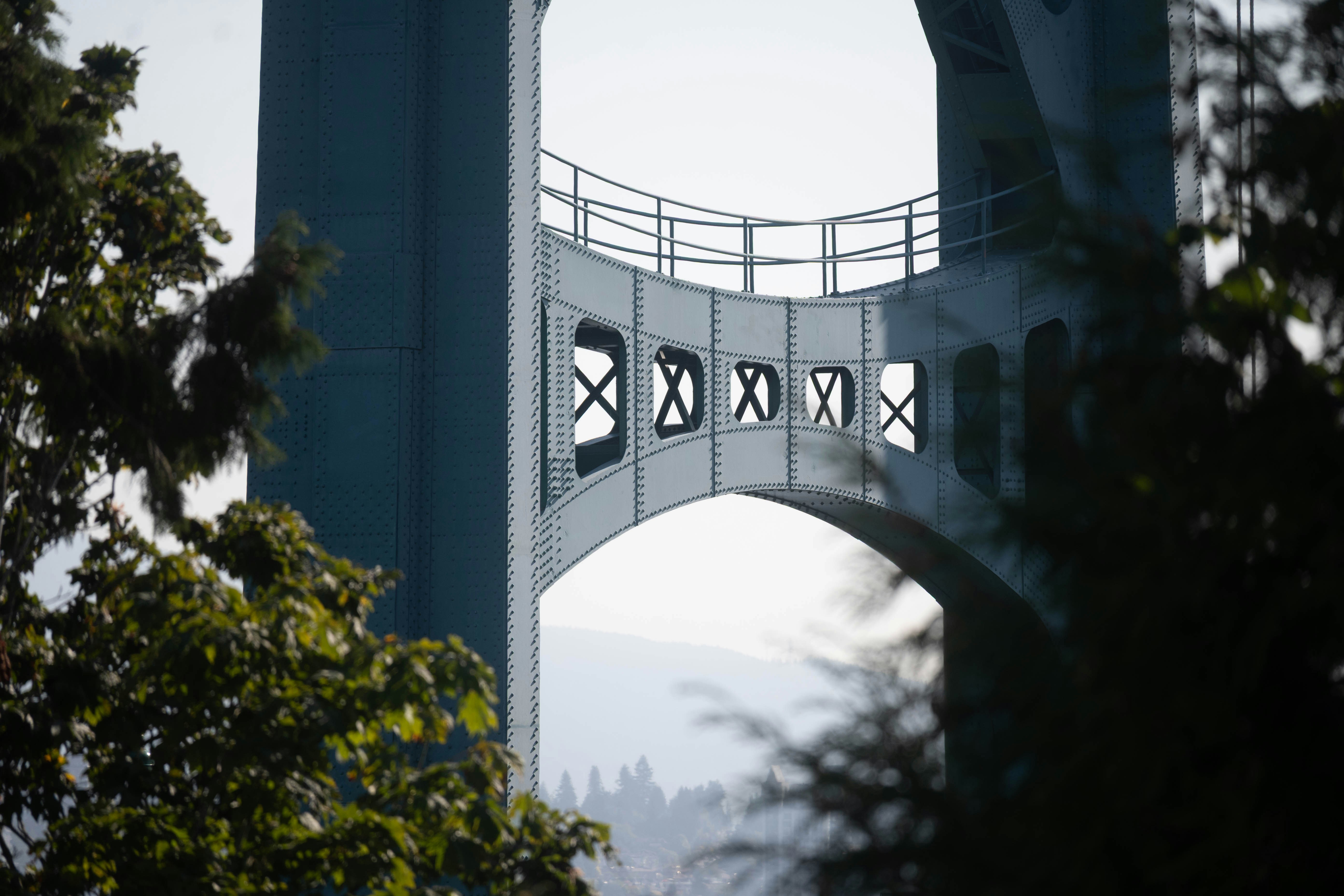 Suspended in Silence: Arched Gateway of a Blue Steel Bridge