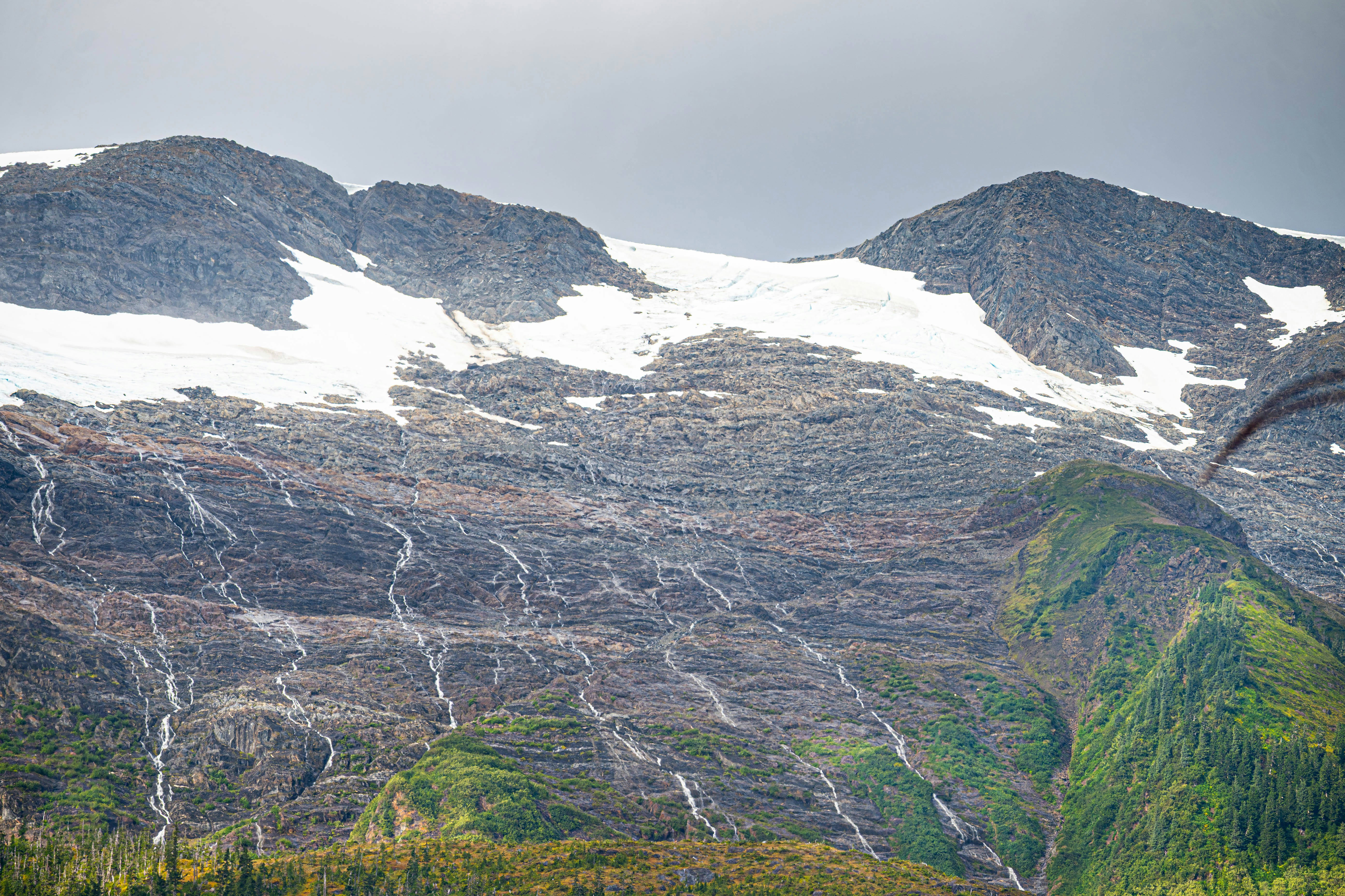 Snow-kissed Ridge Reaching Toward Spring Green