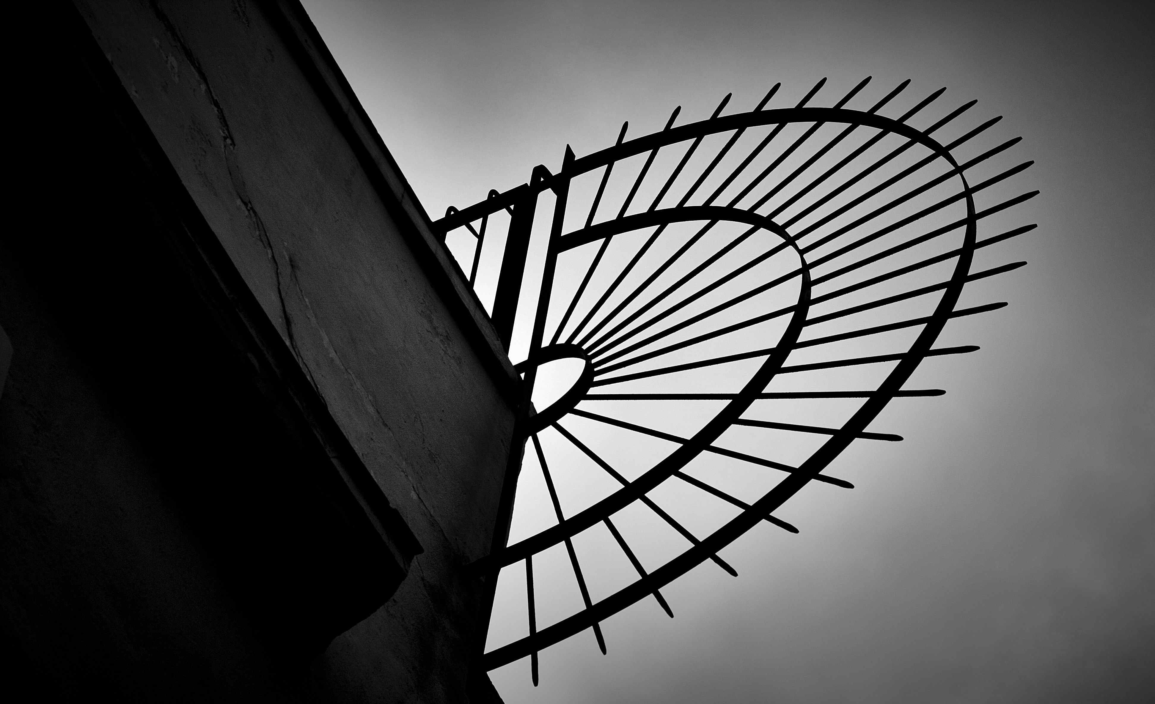 Curved Vigil: The Spiked Balcony Against the Sky