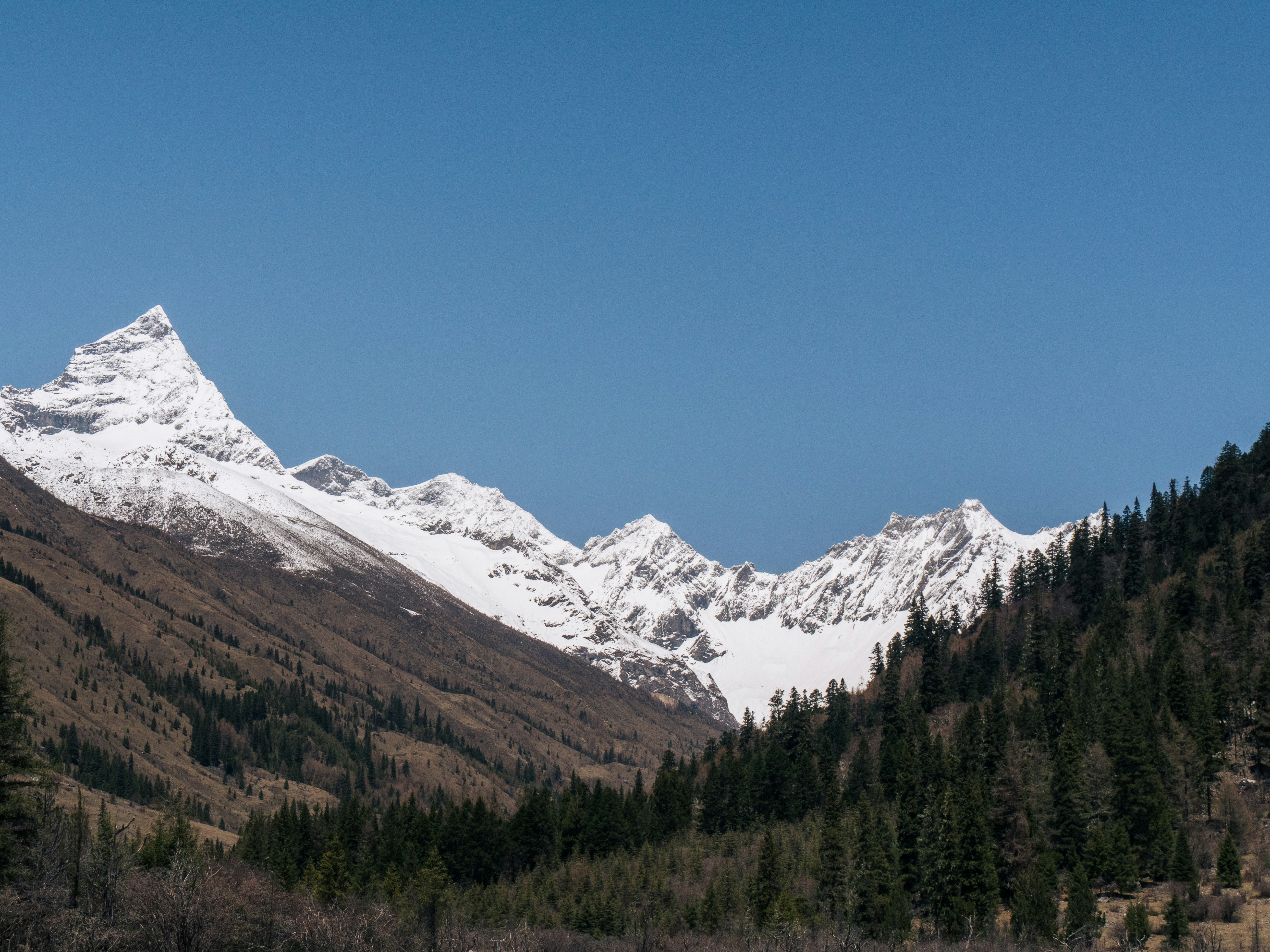 Snow-Capped Peak Ridge Under Clear Sky