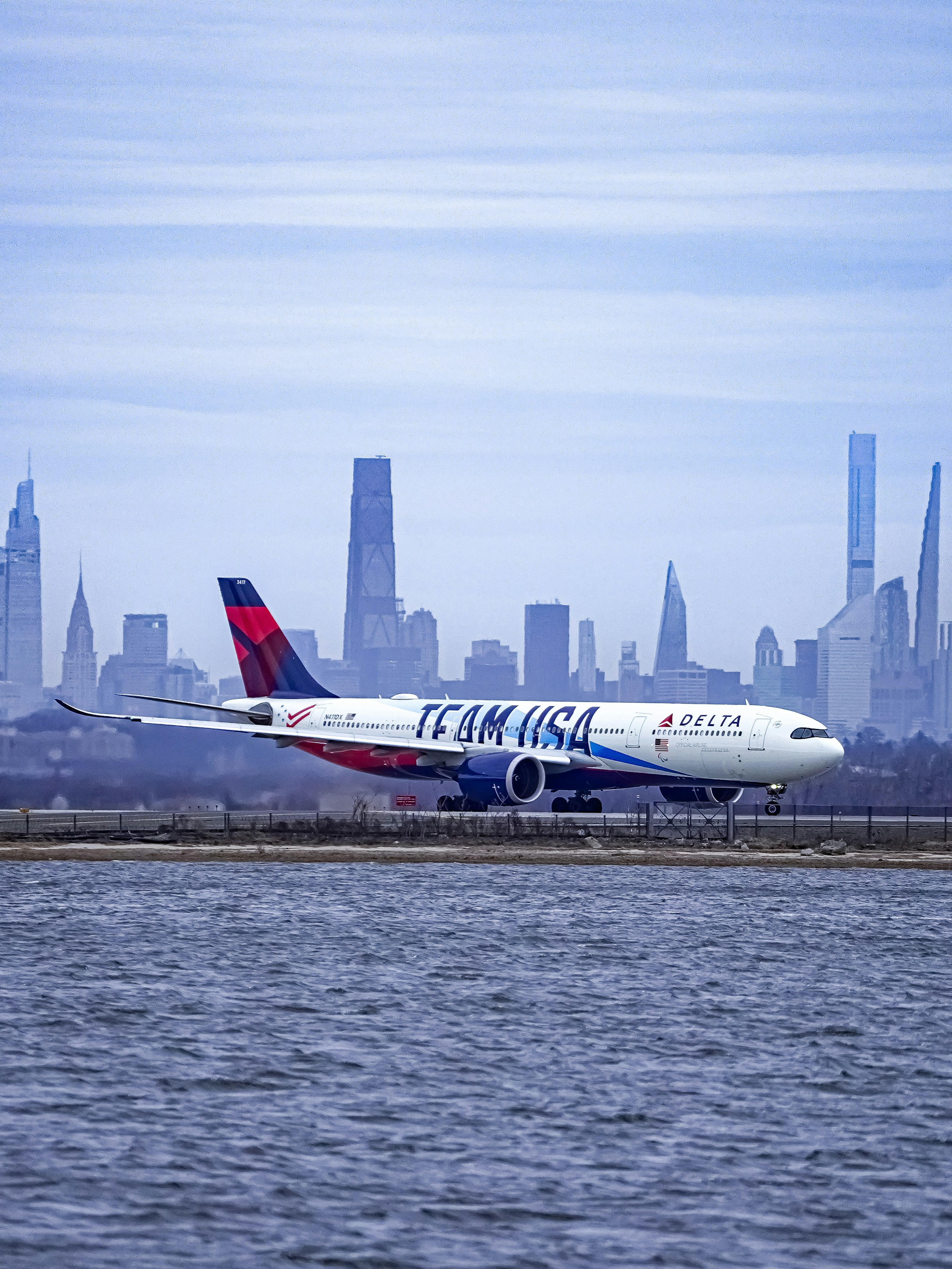 Delta Dreamliner Pierces Dawn over the City