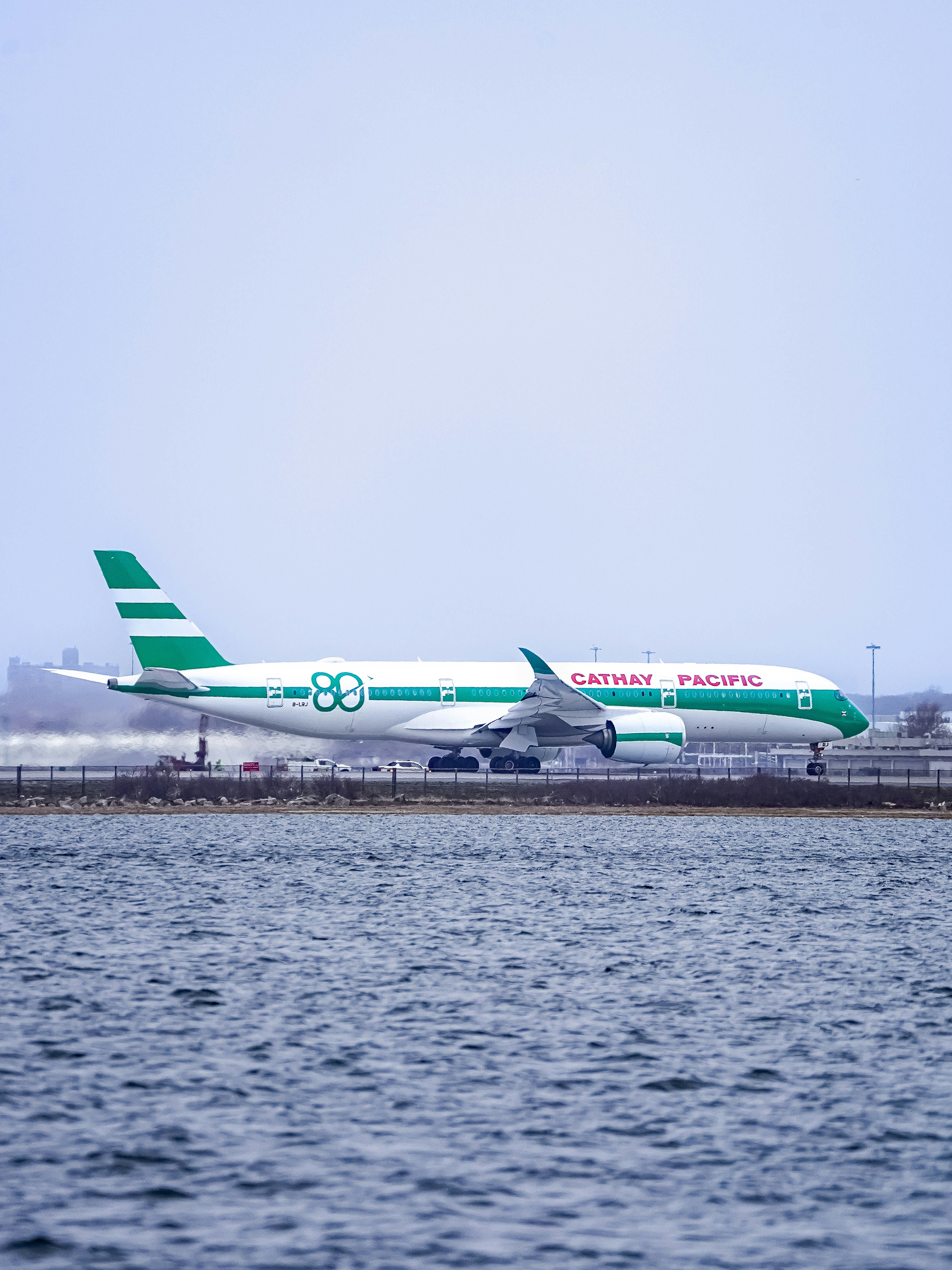 Green Tailed Transformer: Cathay Pacific Jet at the Waterline