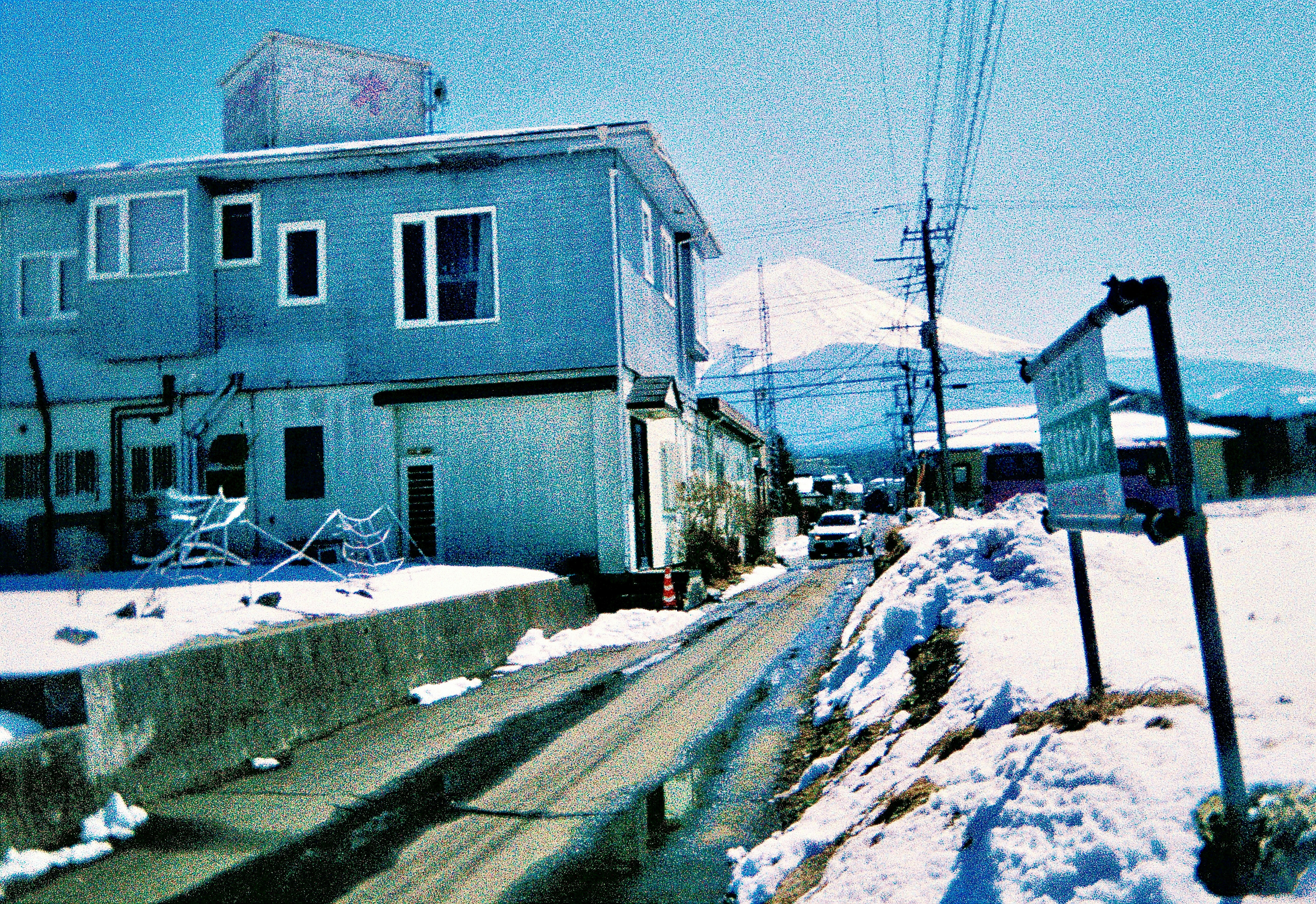 Snowbound Street Under a Blue House Gaze