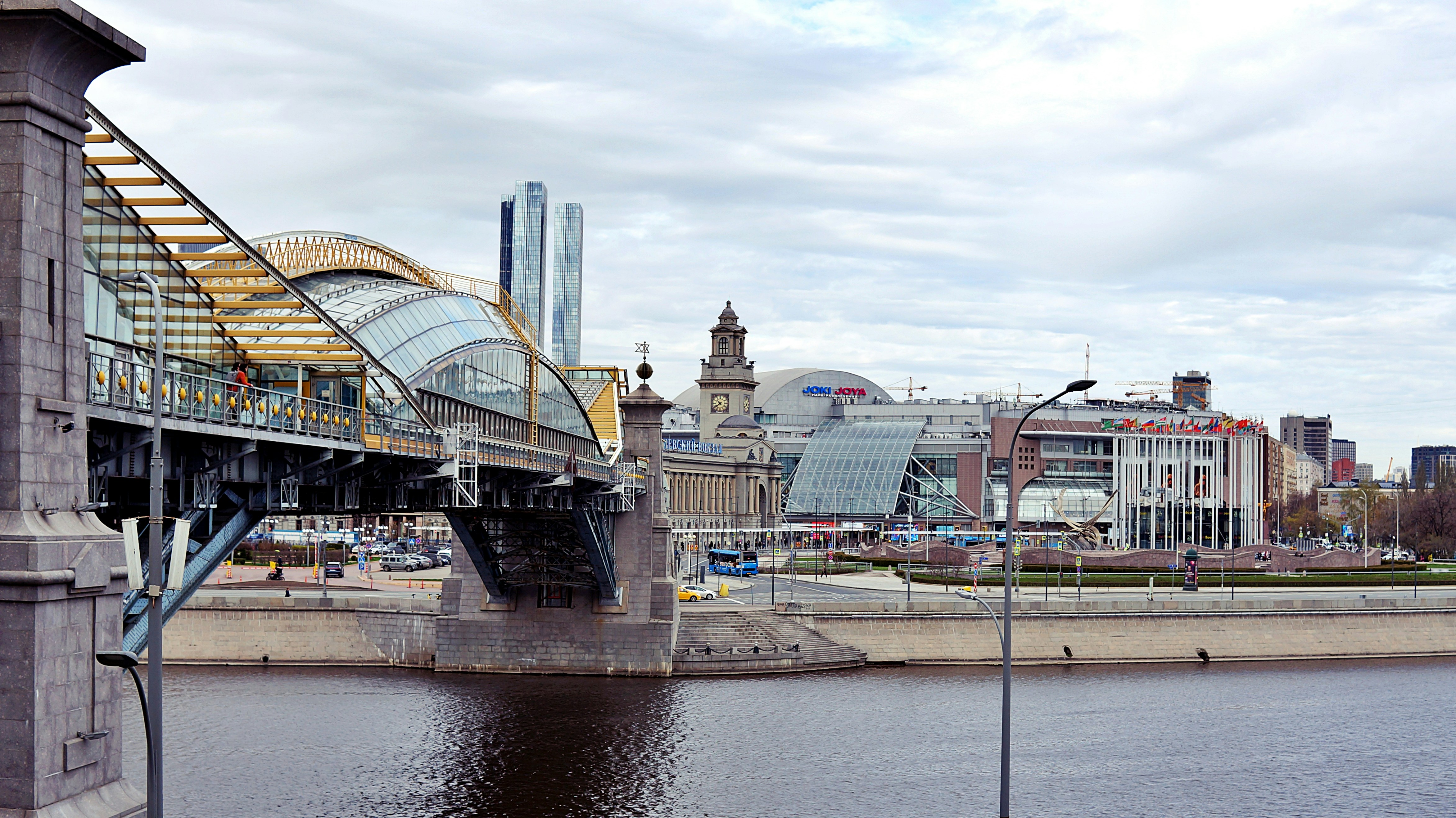 Pedestrian Bridge Over the River Framing a Modern City Core