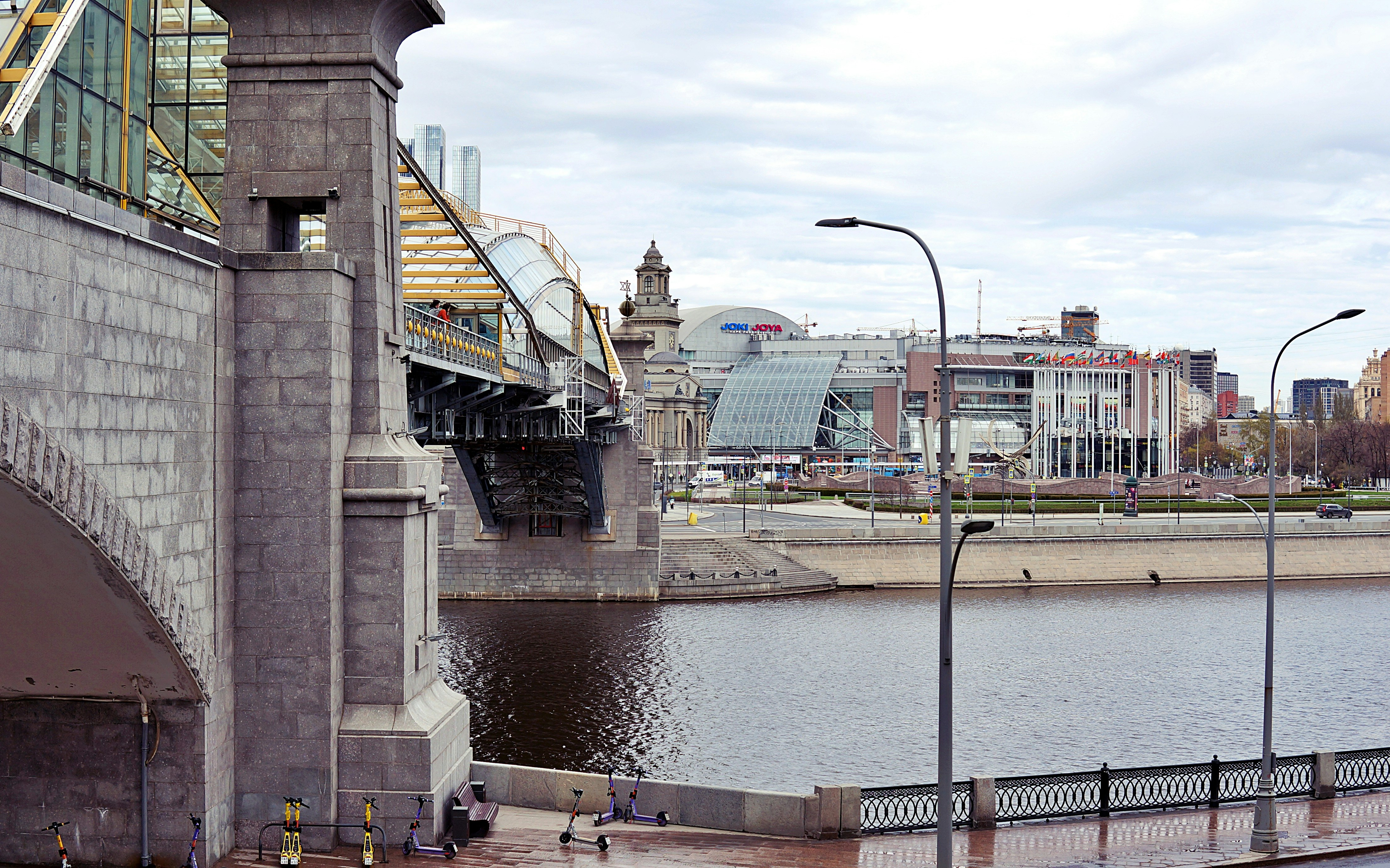 Riverside Bridge with Modern Dome Complex in Soft Evening Light