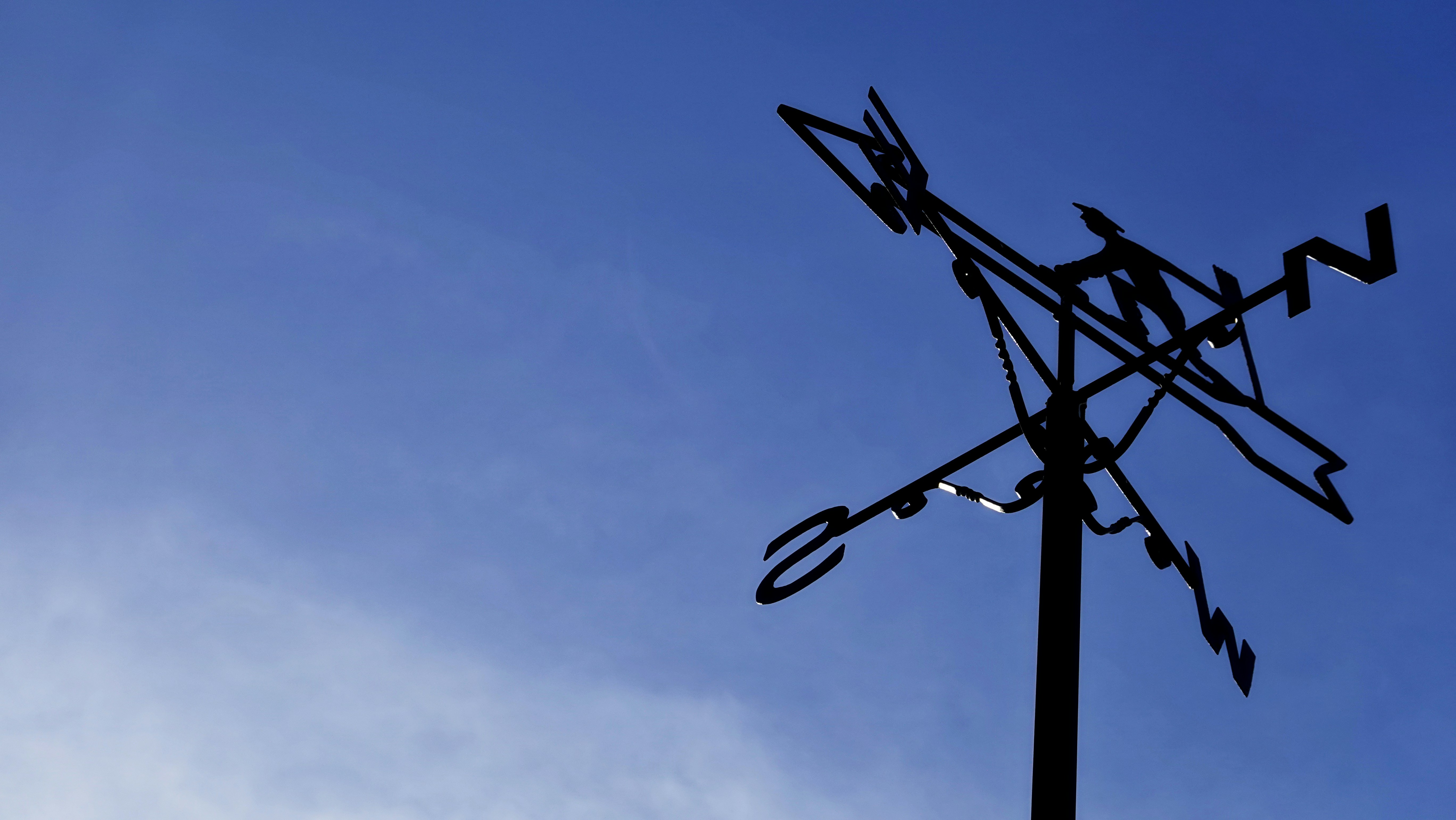 Silhouette of a Weather Vane Against a Quiet Sky