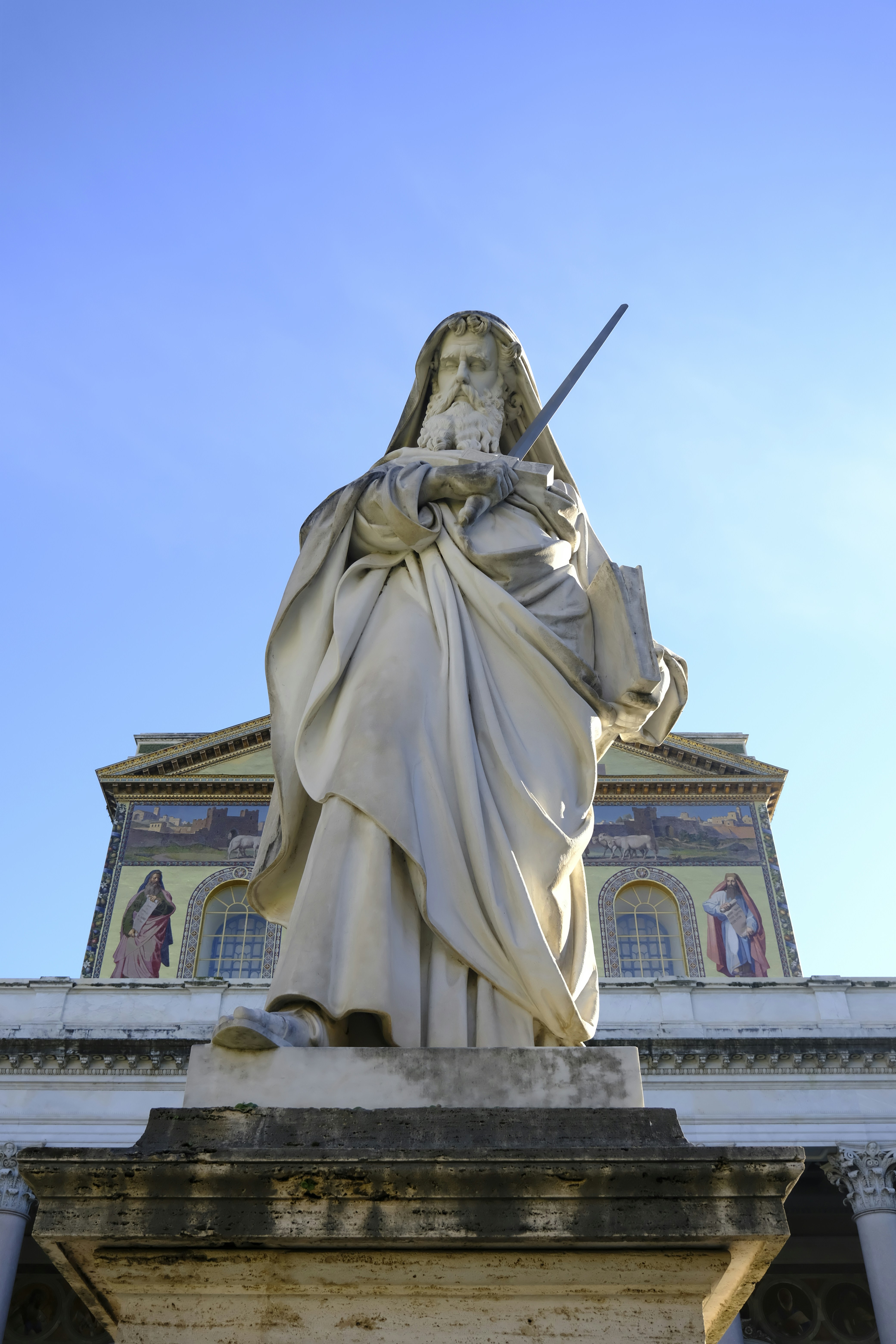 Giant Granite Sage with Raised Sword under Clear Day