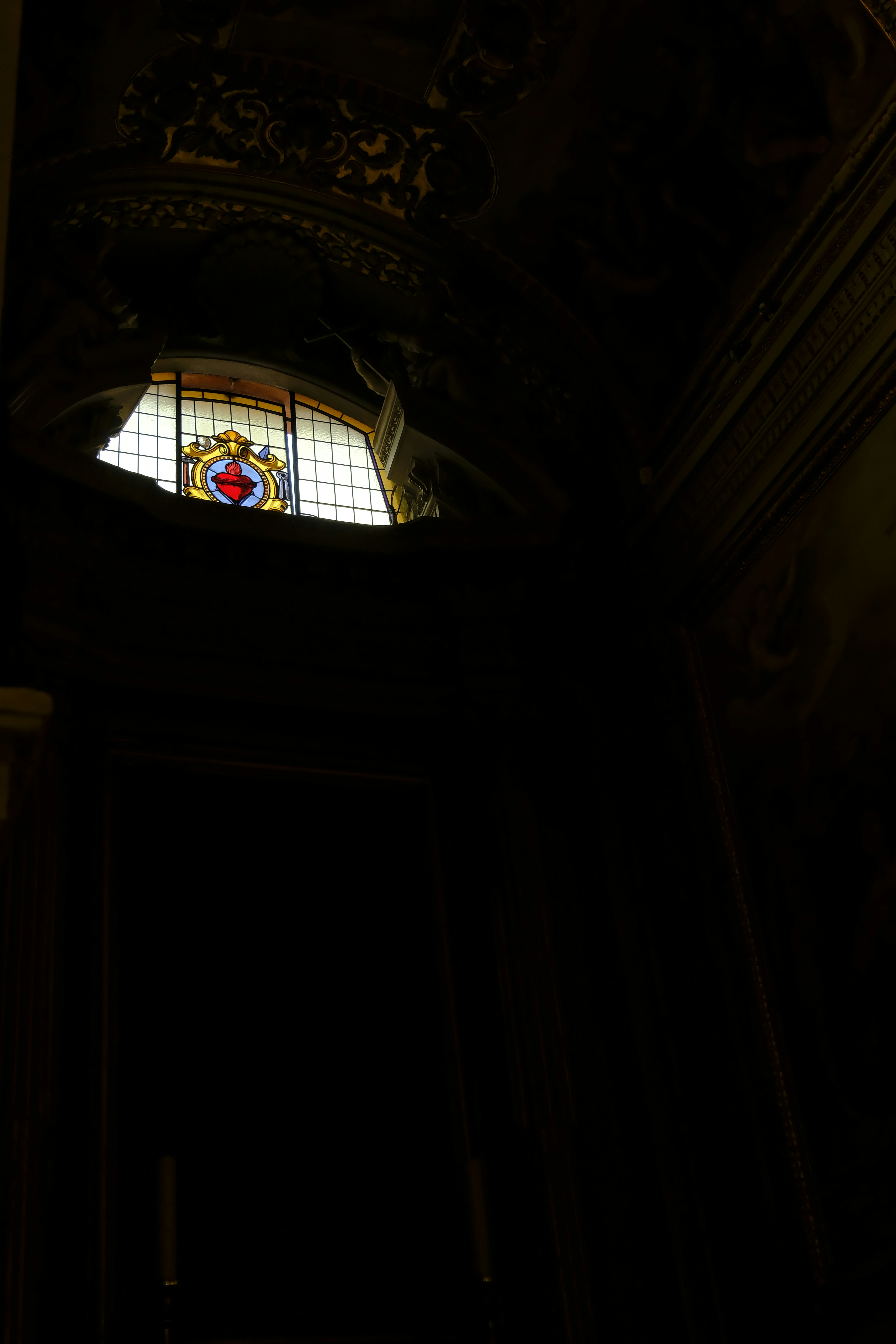 Stained-Glass Glow Above Dark Archway