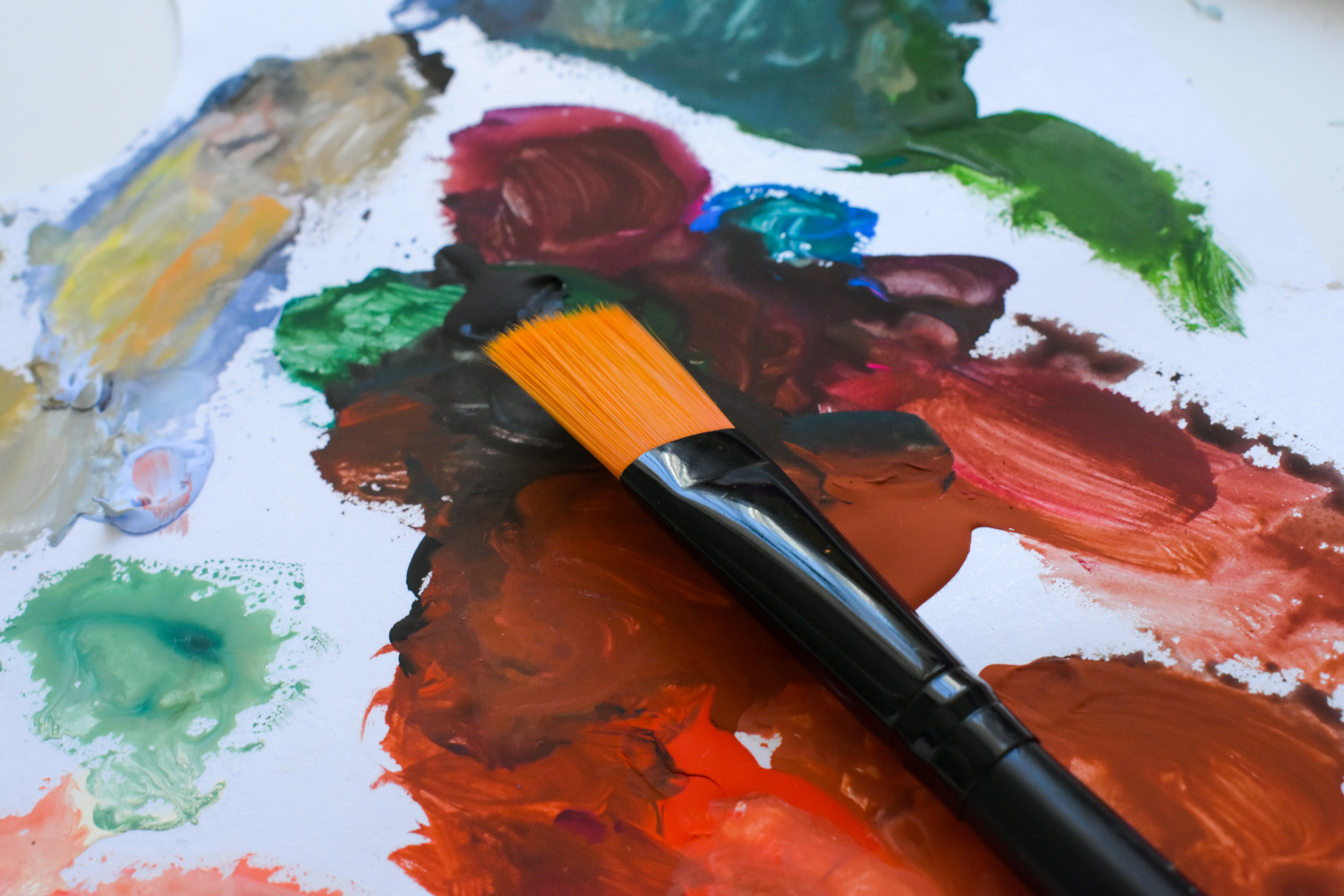 Broad swathes of pigment: a painterly studio moment with a bright brush