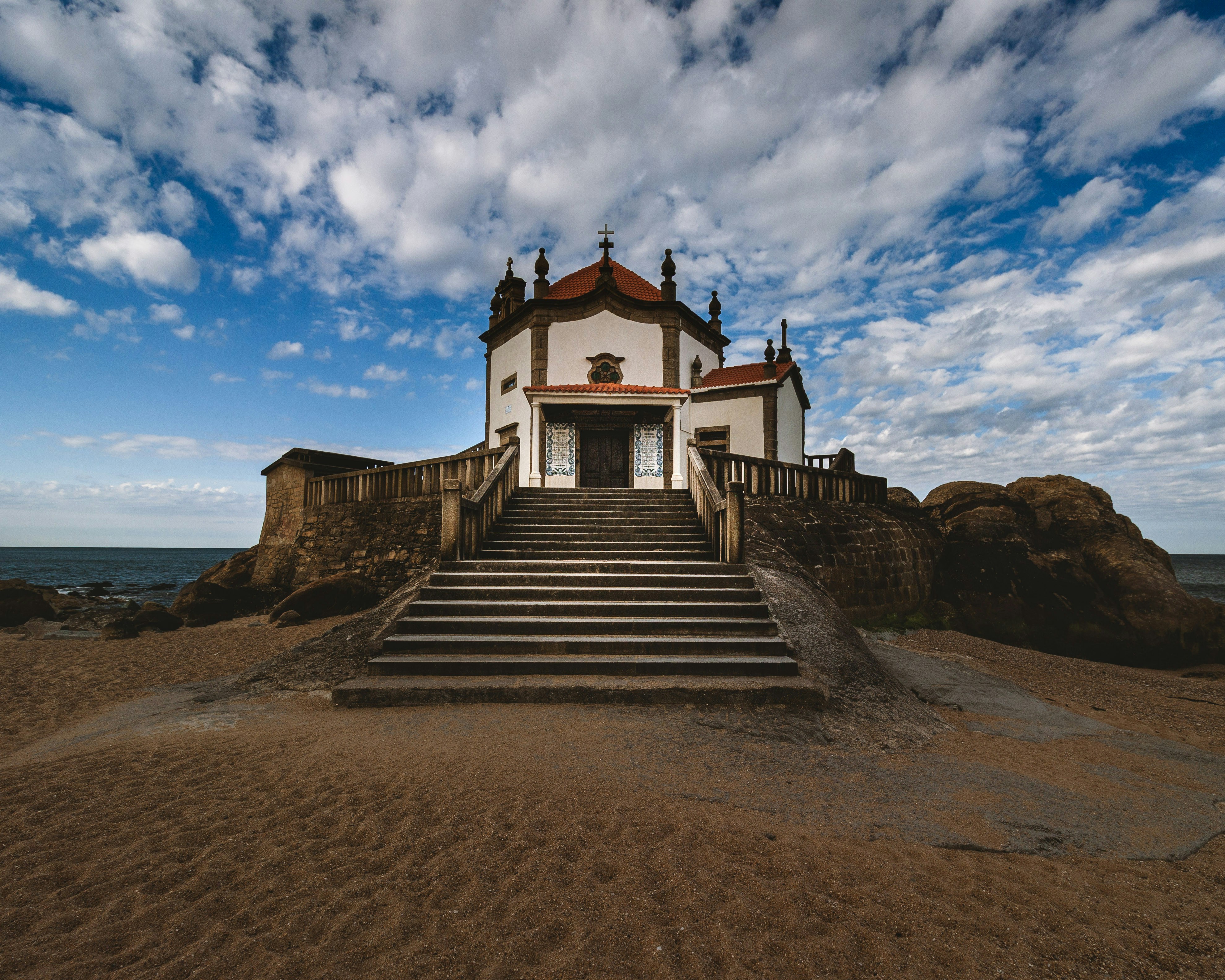 Steps to a Cliffside Chapel: A Coastal Red-Roofed haven