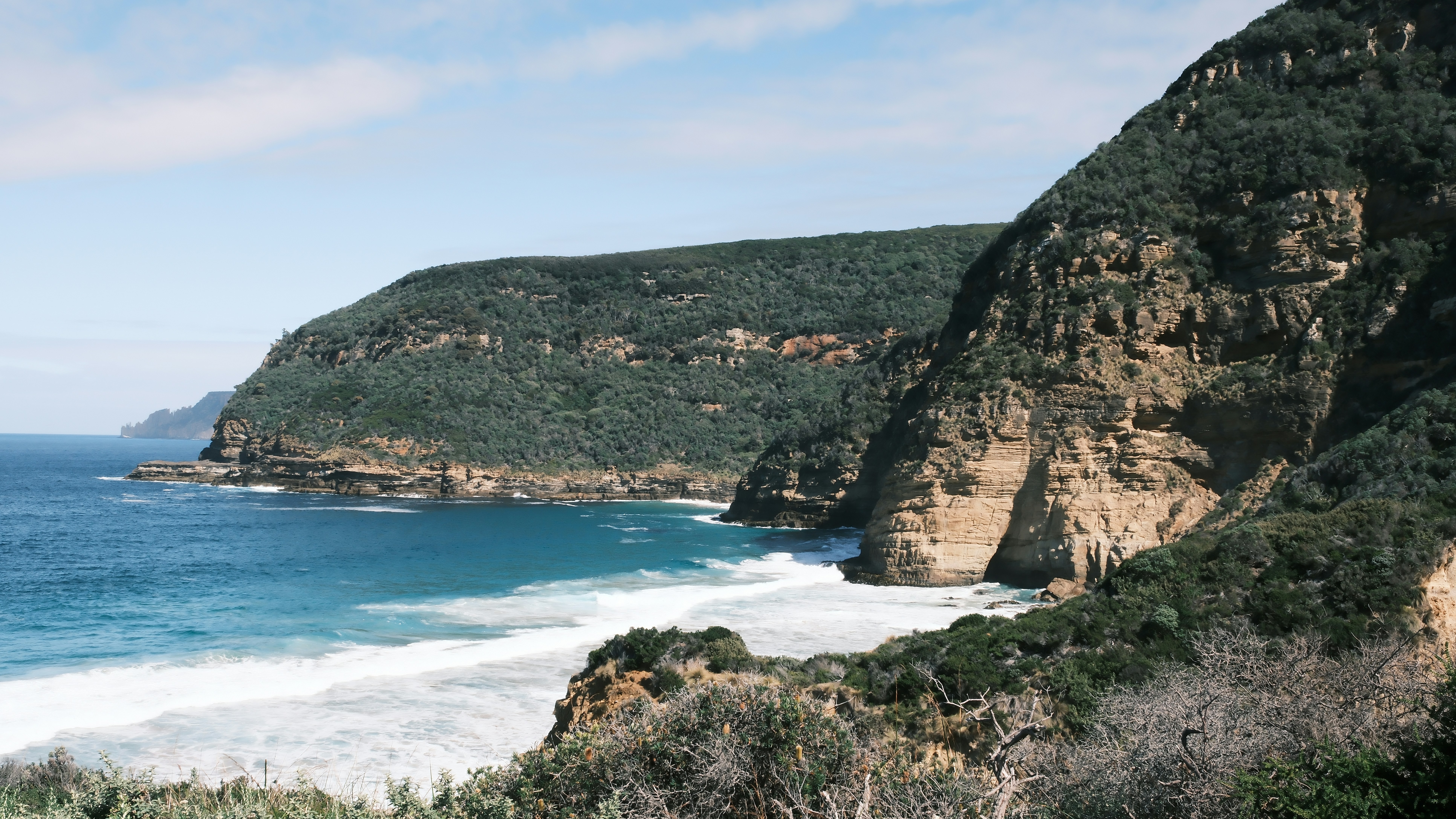 Cliffside coastline under a clear coastal sky