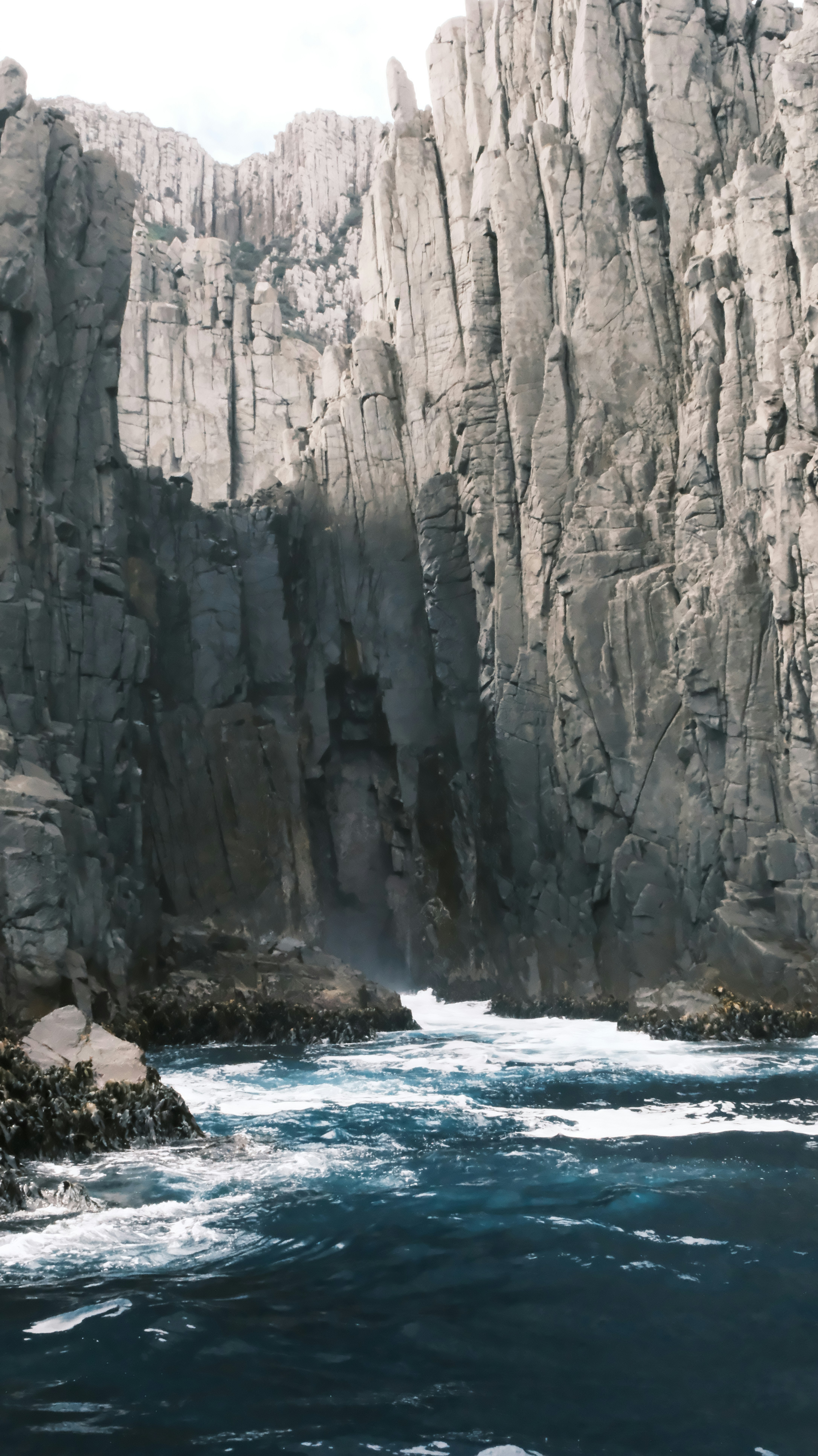 Sea Cliff Confluence: Towering Basalt Faces Meet Roaring Atlantic