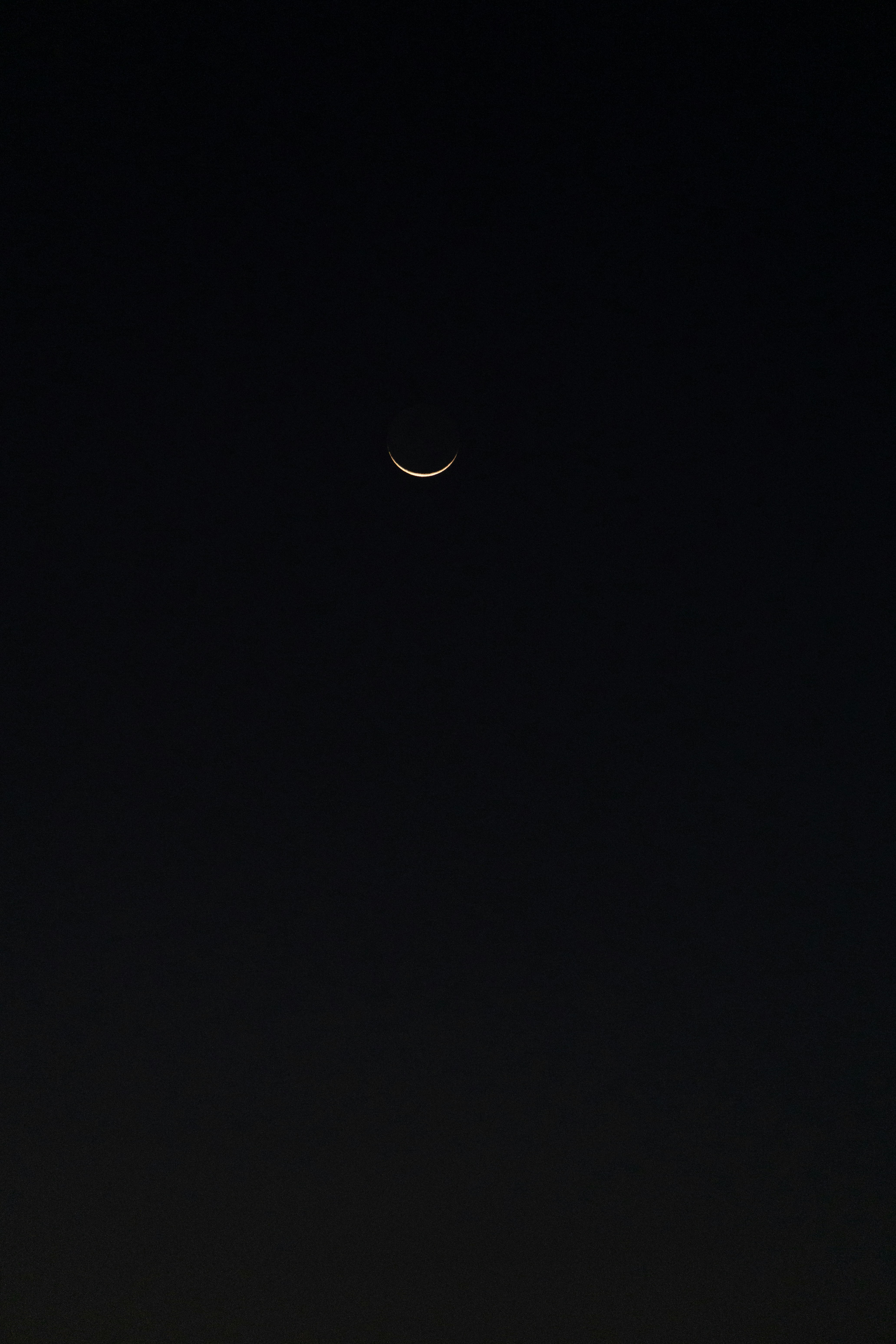 Halo of Night: Crescent Moon Over Quiet Black