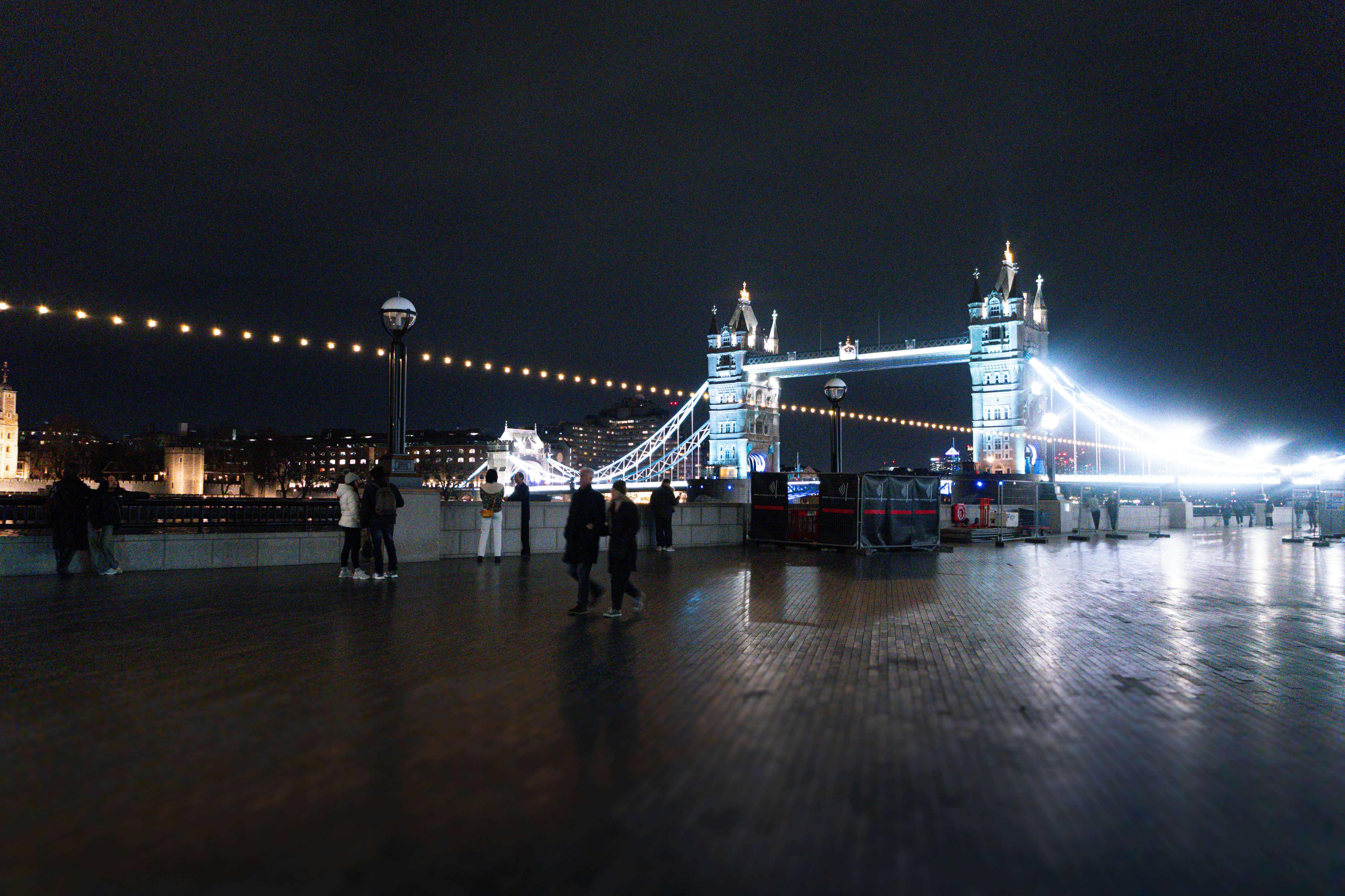 Tower Bridge illumined at night from the Thames embankment
