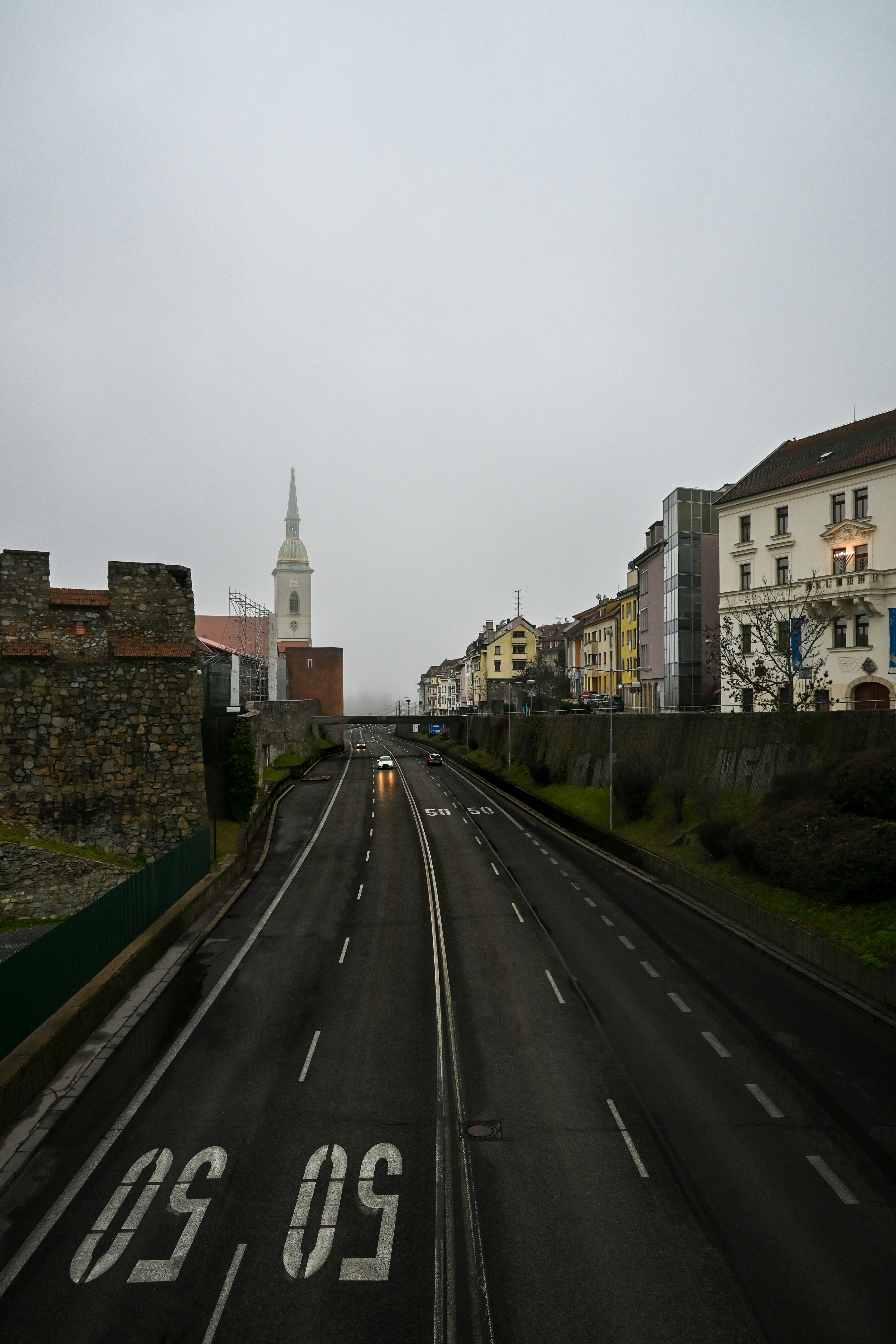 Towards the Town Clock: A Vanishing Highway Under an Overcast Sky