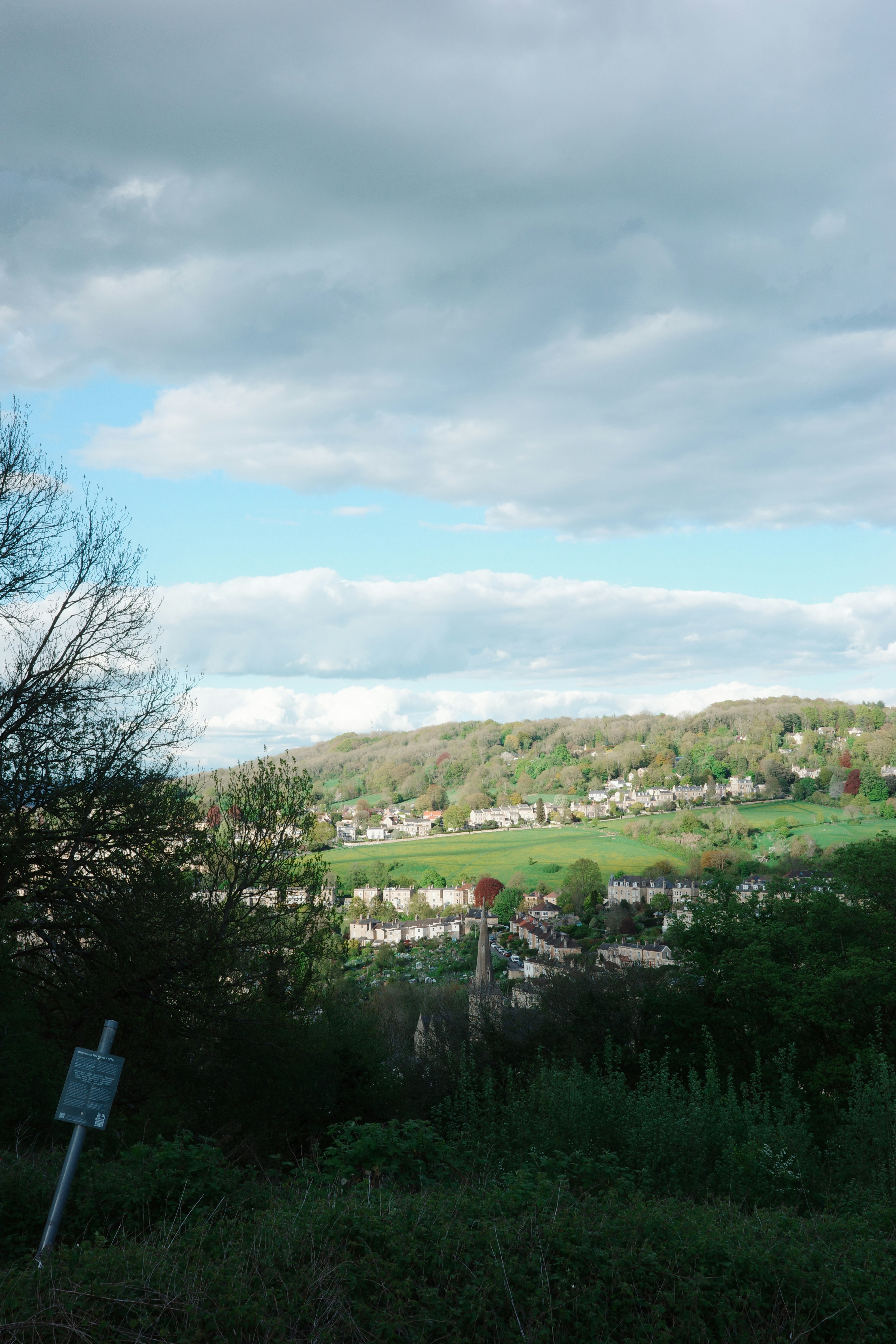 Hilltop Village Nestled in Verdant Valleys Under Expansive Sky